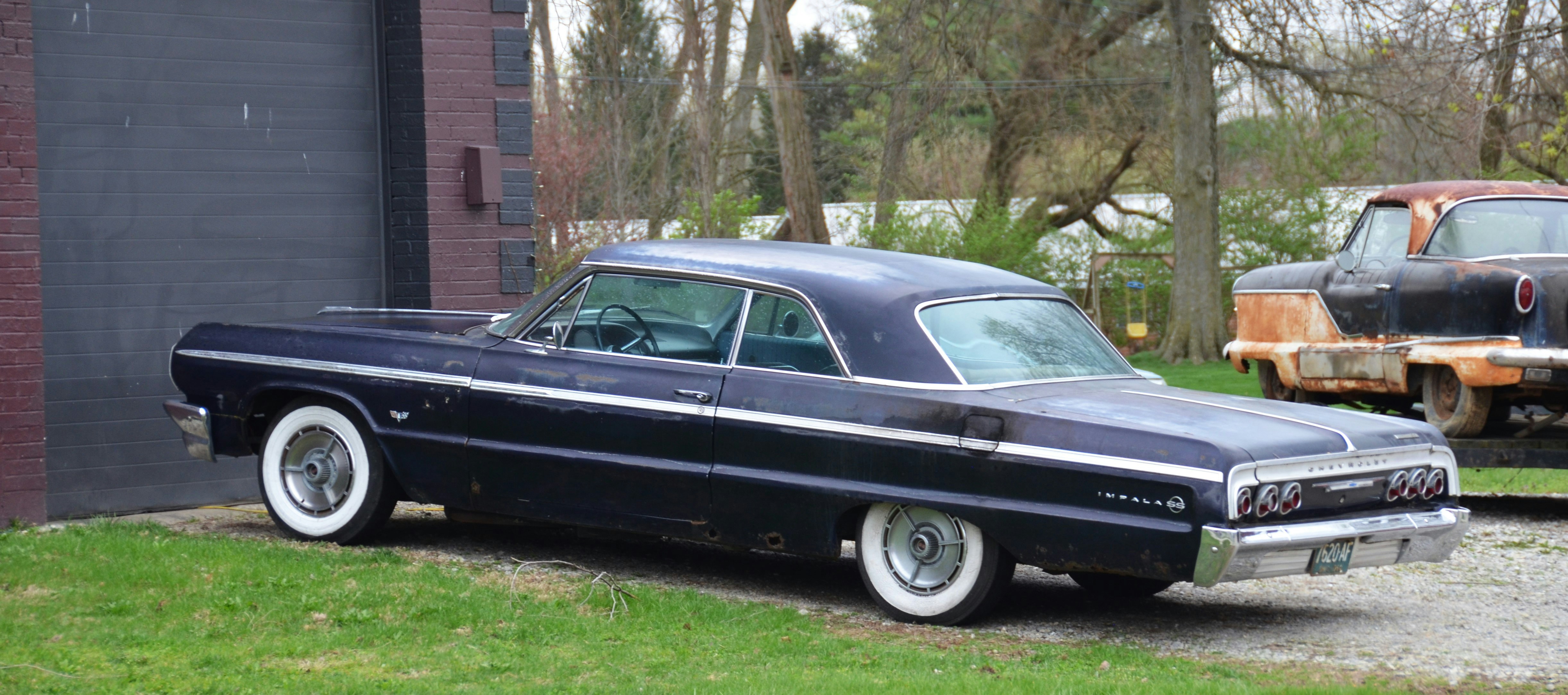 Midnight Cruiser on Grass: A 1960s Cadillac Quietly Resting