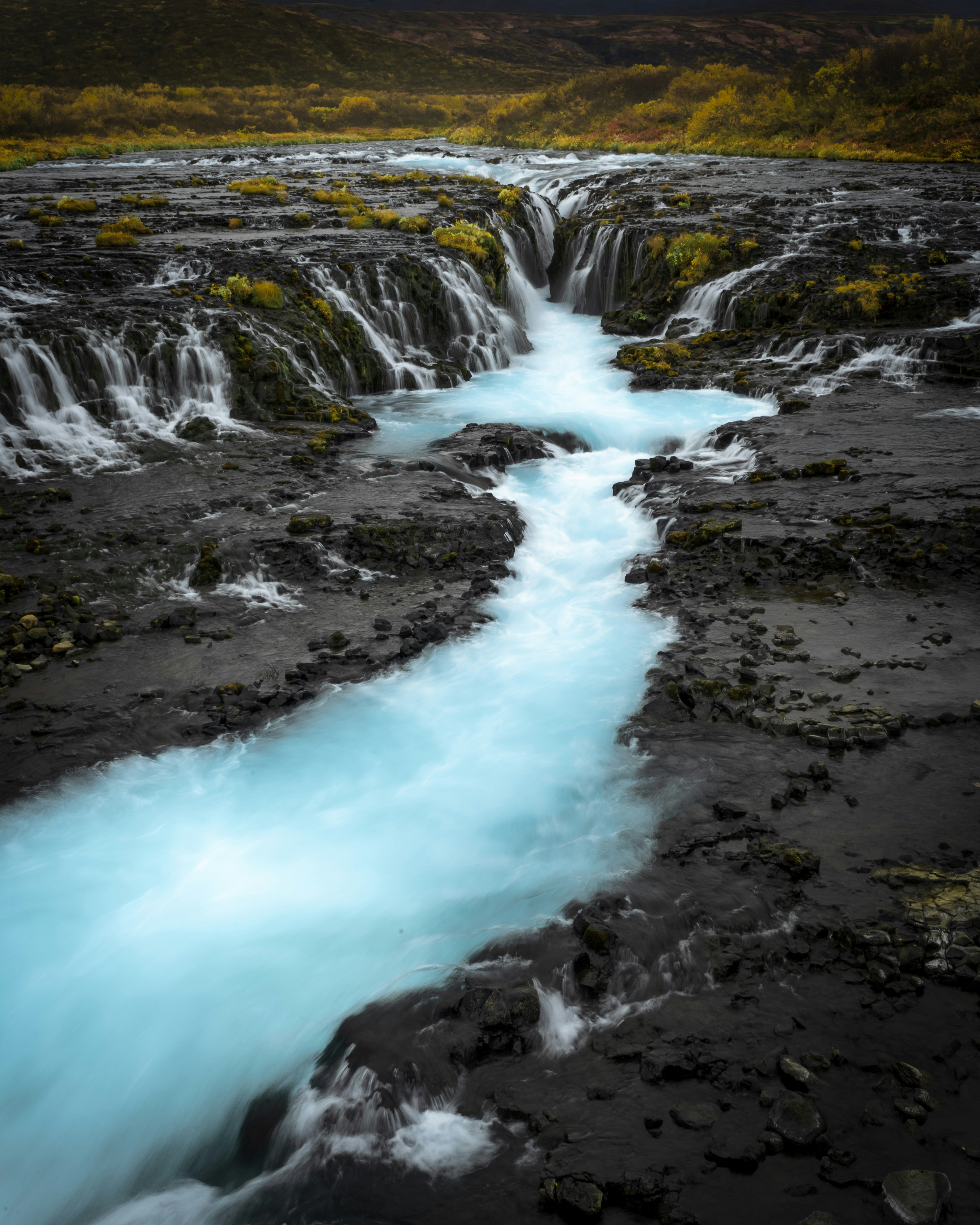 Electric Highway: A Turquoise Ribbon Carves Through volcanic Black Rock