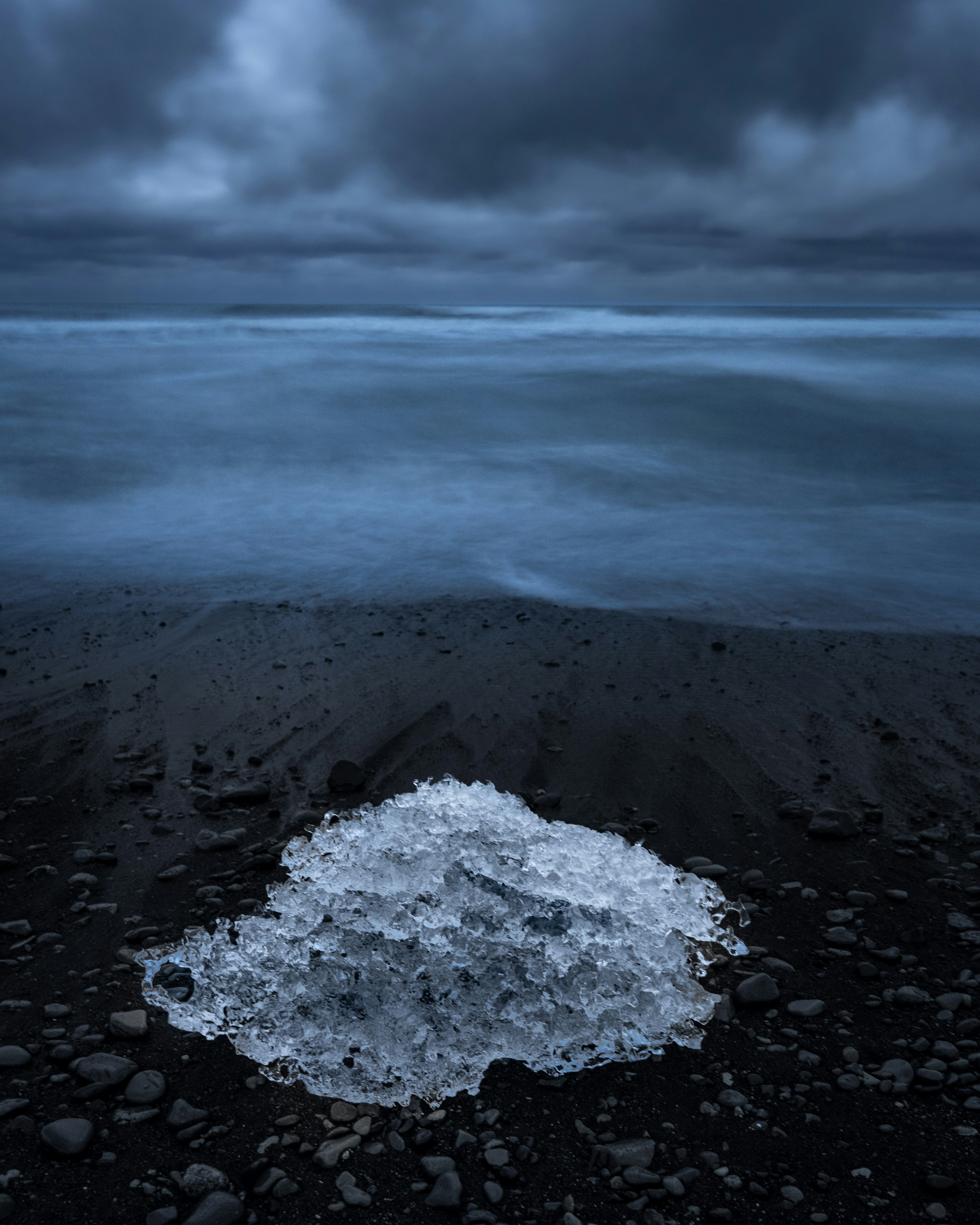 Frosted Ocean Edge under Stormy Skies
