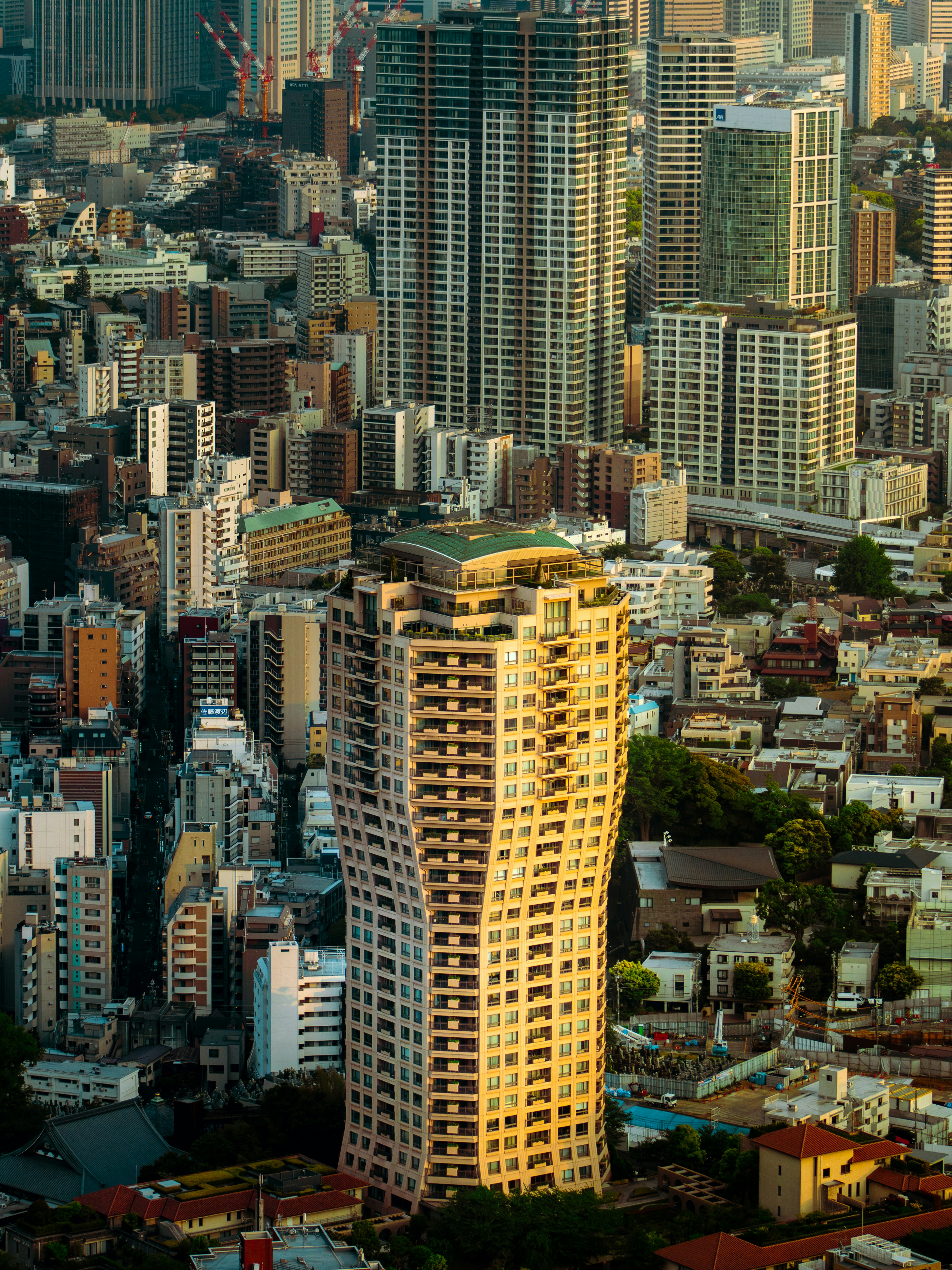The Curved Tower Rising Among a Tessellation of Glass and Brick
