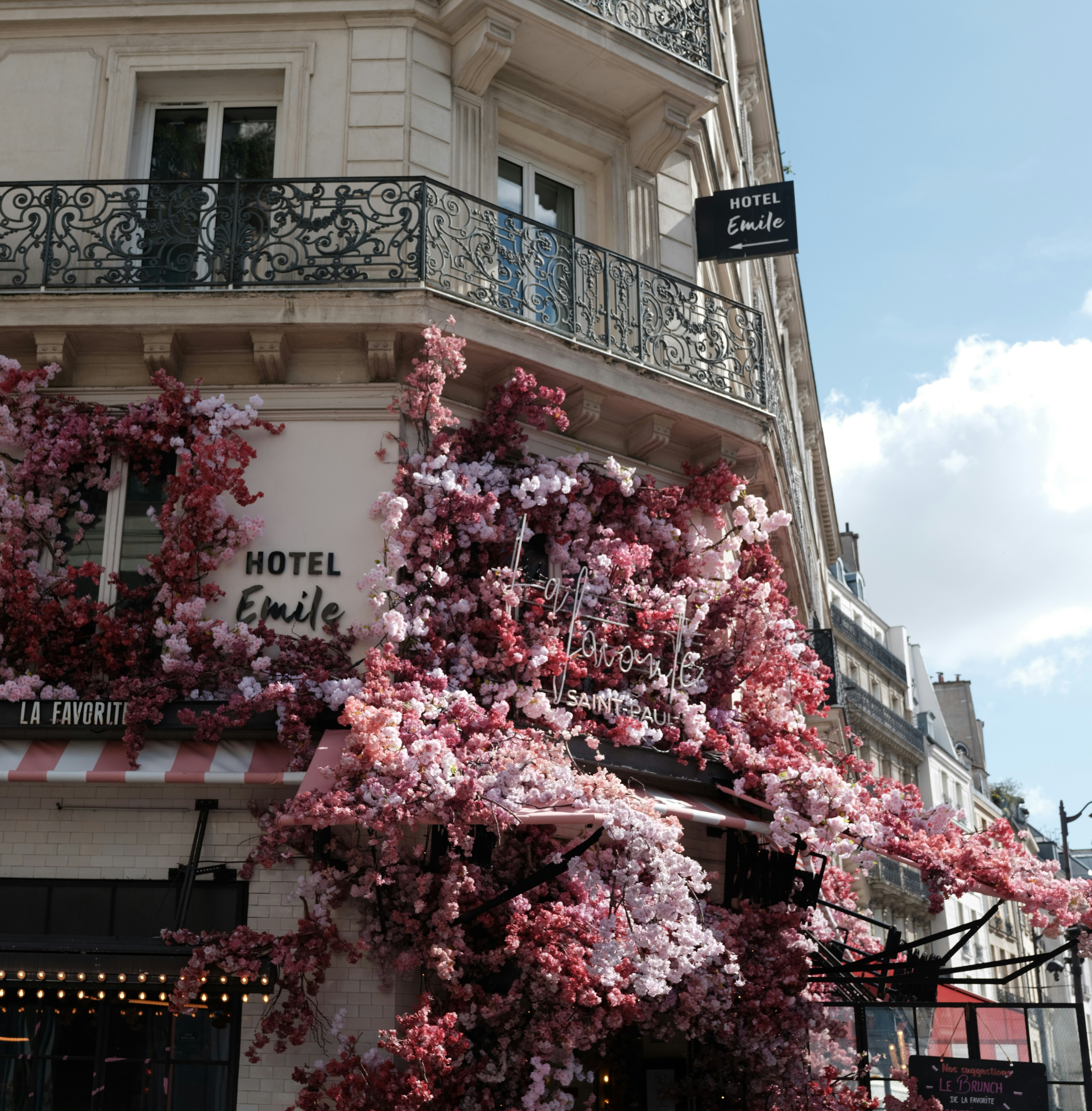 Blossoming Hotel Emile Signage Along Parisian Facade