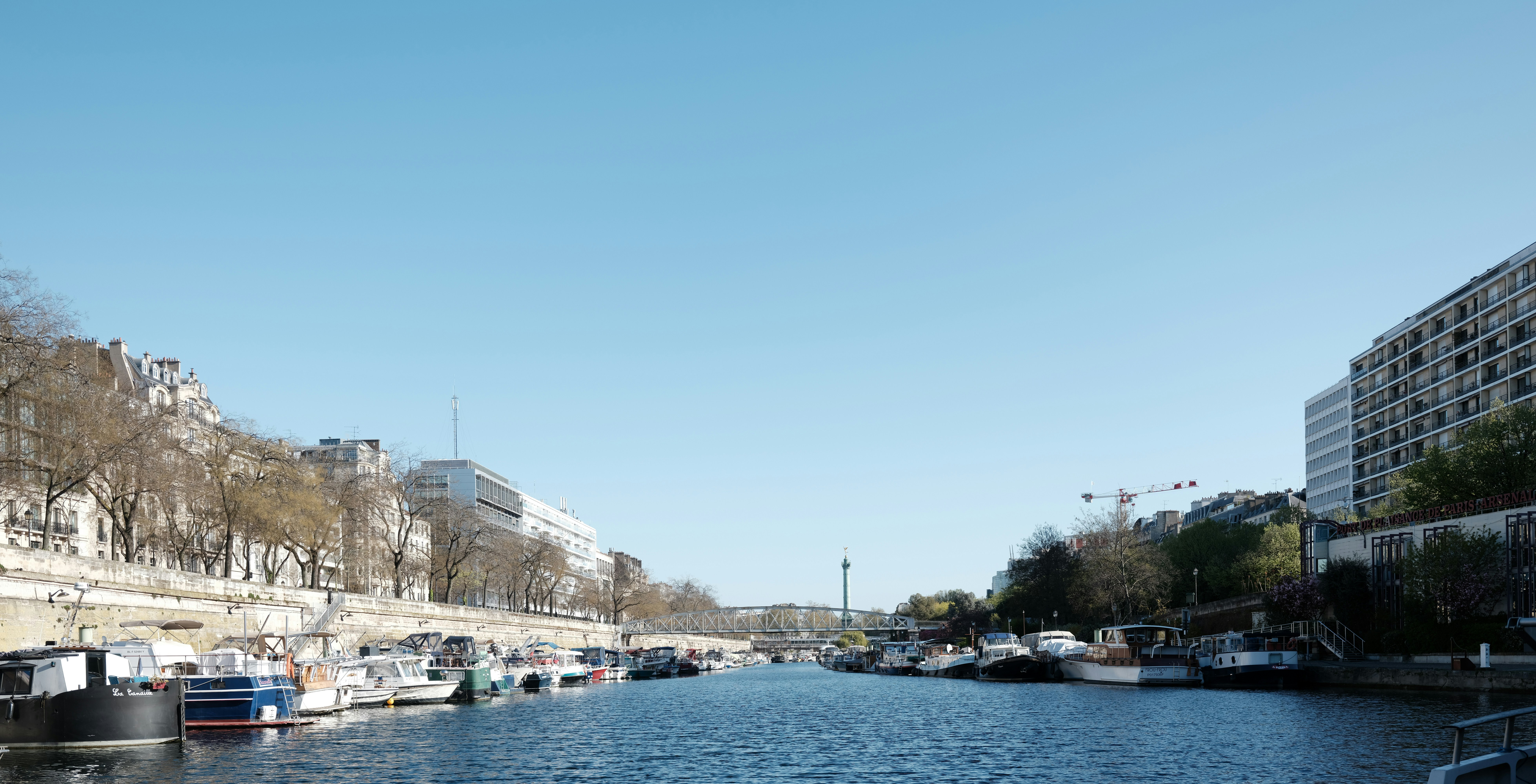 Toward the City’s Heart: Boats, Bridge, and Bright Sky along the Canal