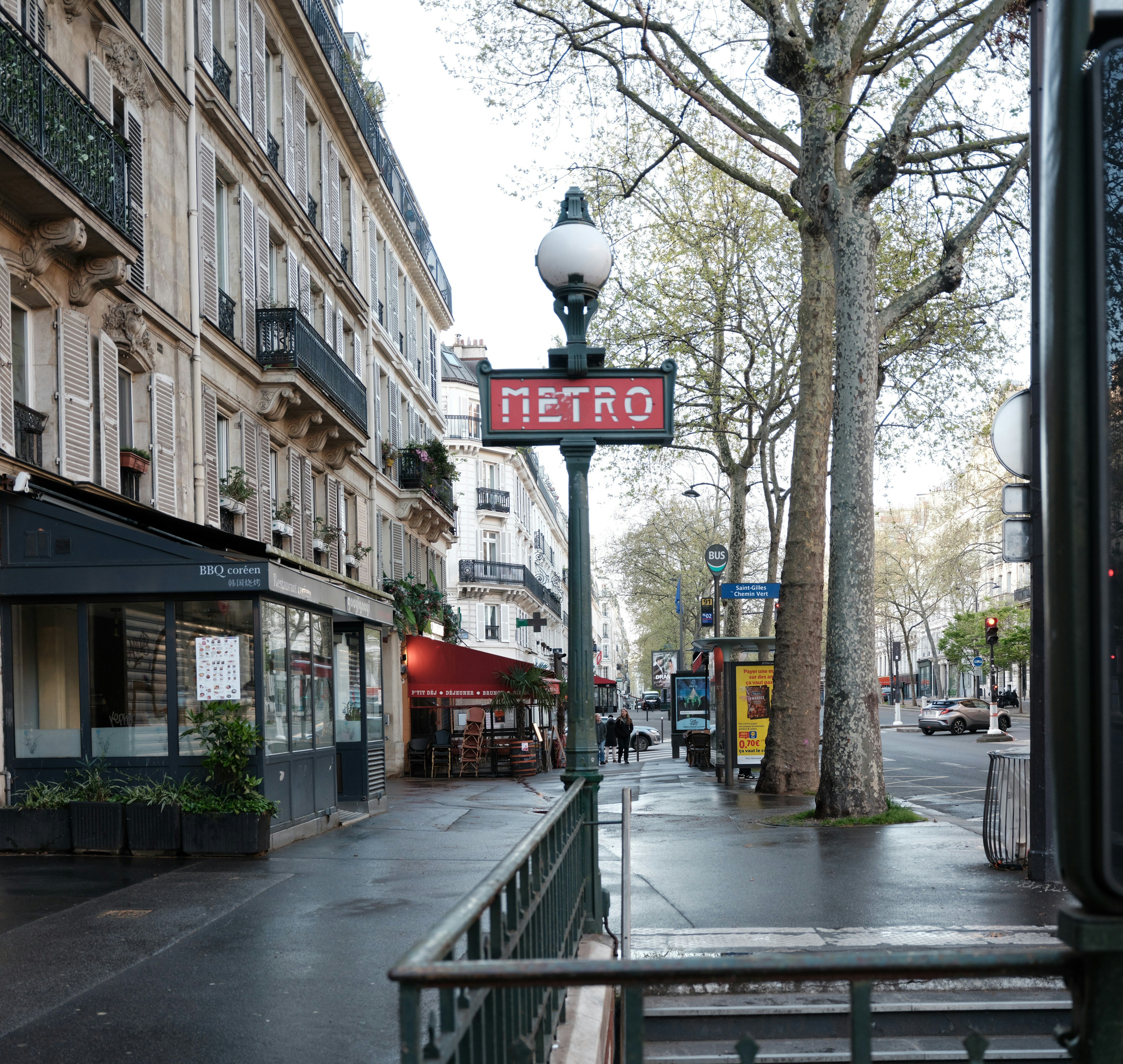 Metro Signstand: A Parisian Street Scene Framed by Trees