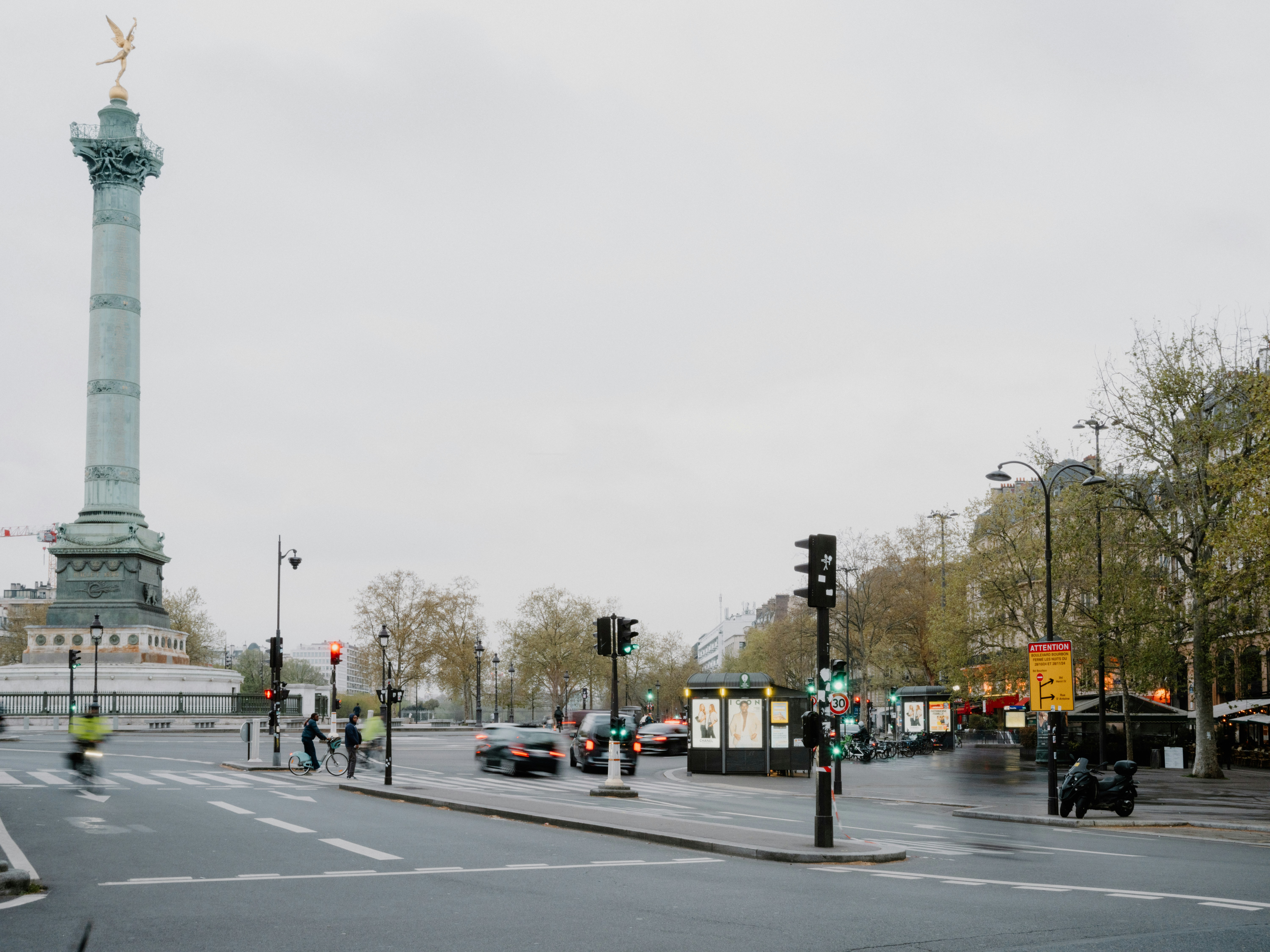 Column with statue overlooking a quiet Parisian boulevard