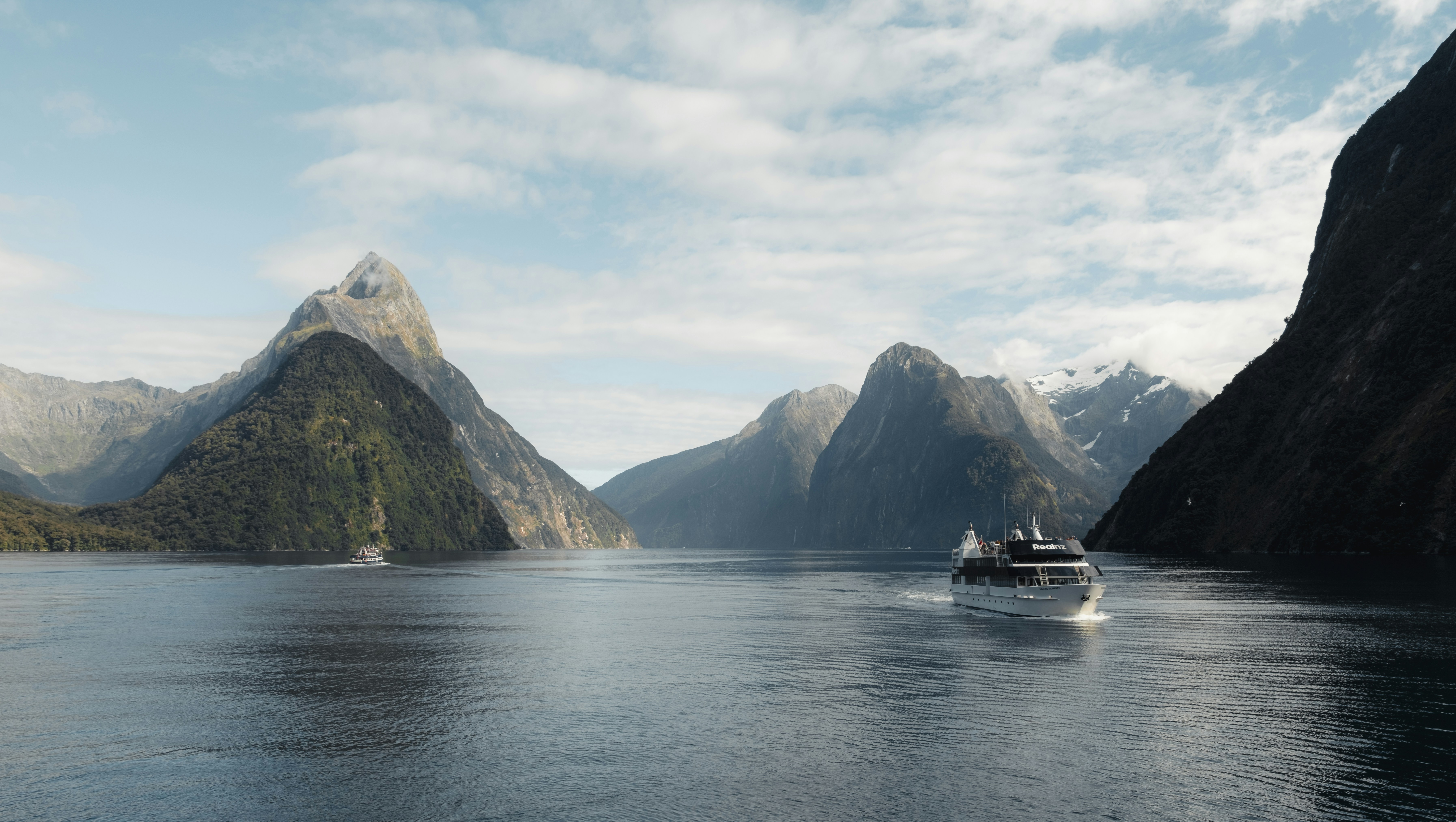 Misty Fjord Passage: A Vessel Traverses Between Towering Peaks