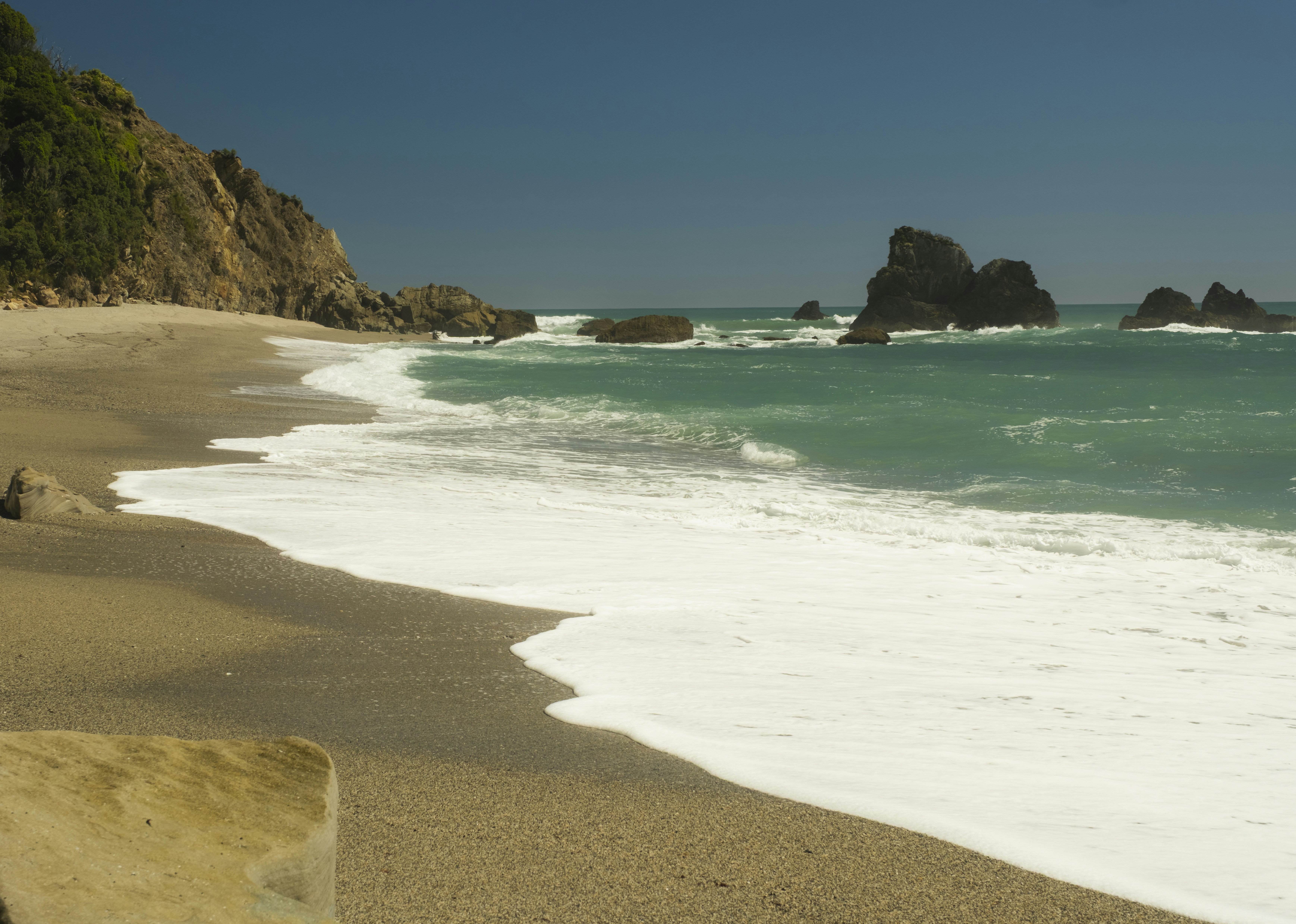 Coastal Perimeter: Sunlit Beach and Sea Stack silhouettes