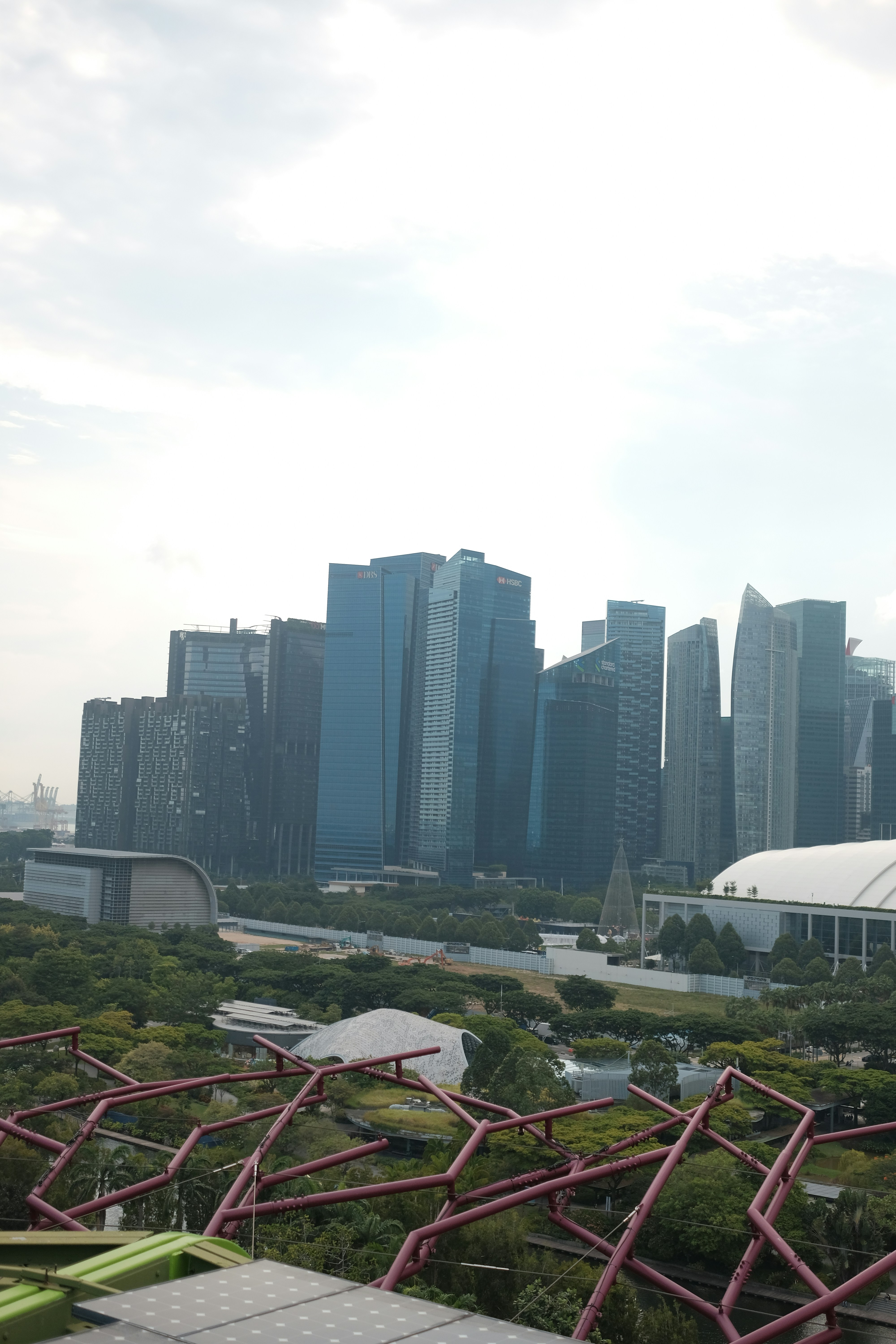 Skyline in Focus: A Modern City Rise Above a Red Geometric Walkway