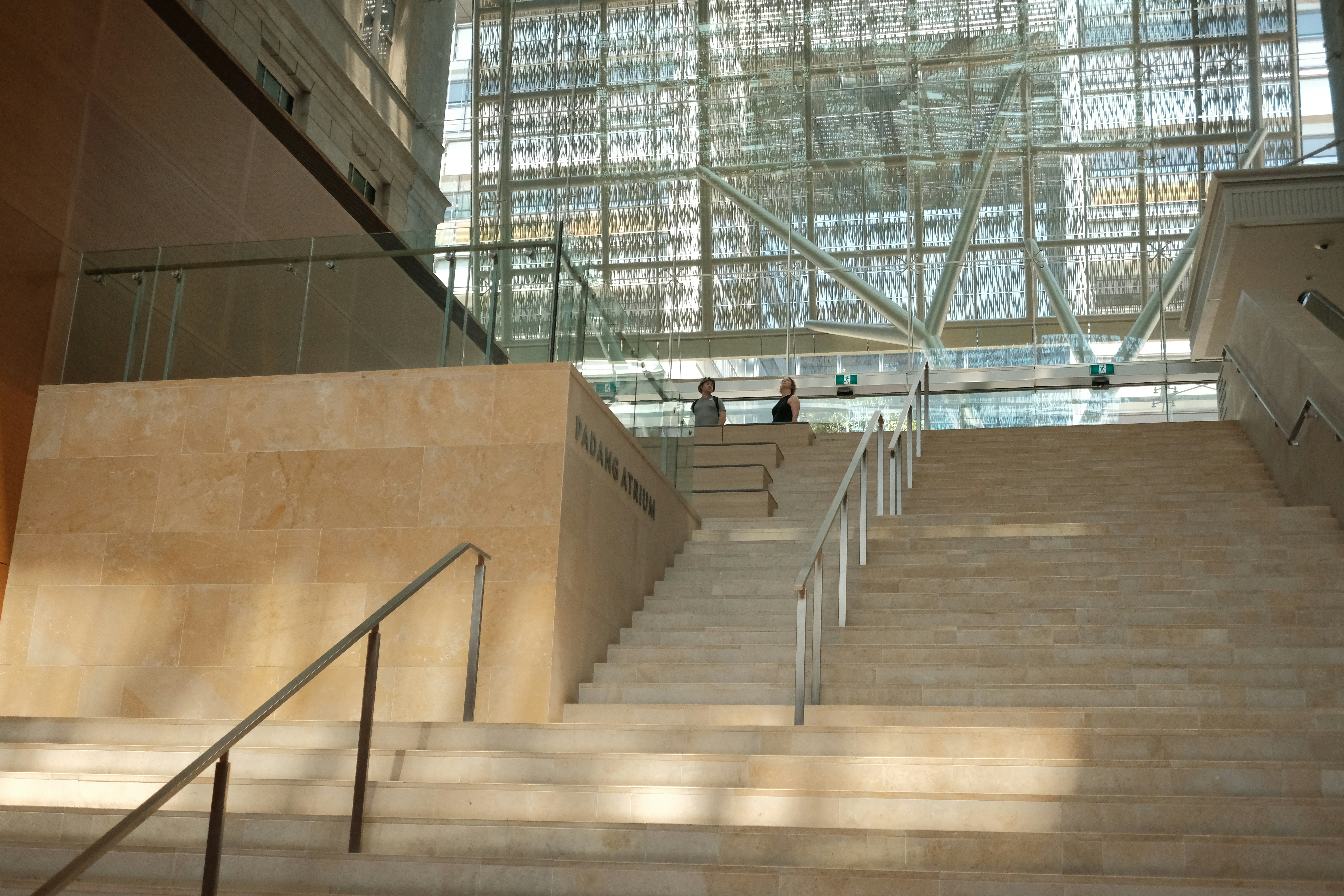 Glassy Atrium Ascent: Sunlit Steps to Quiet Horizon