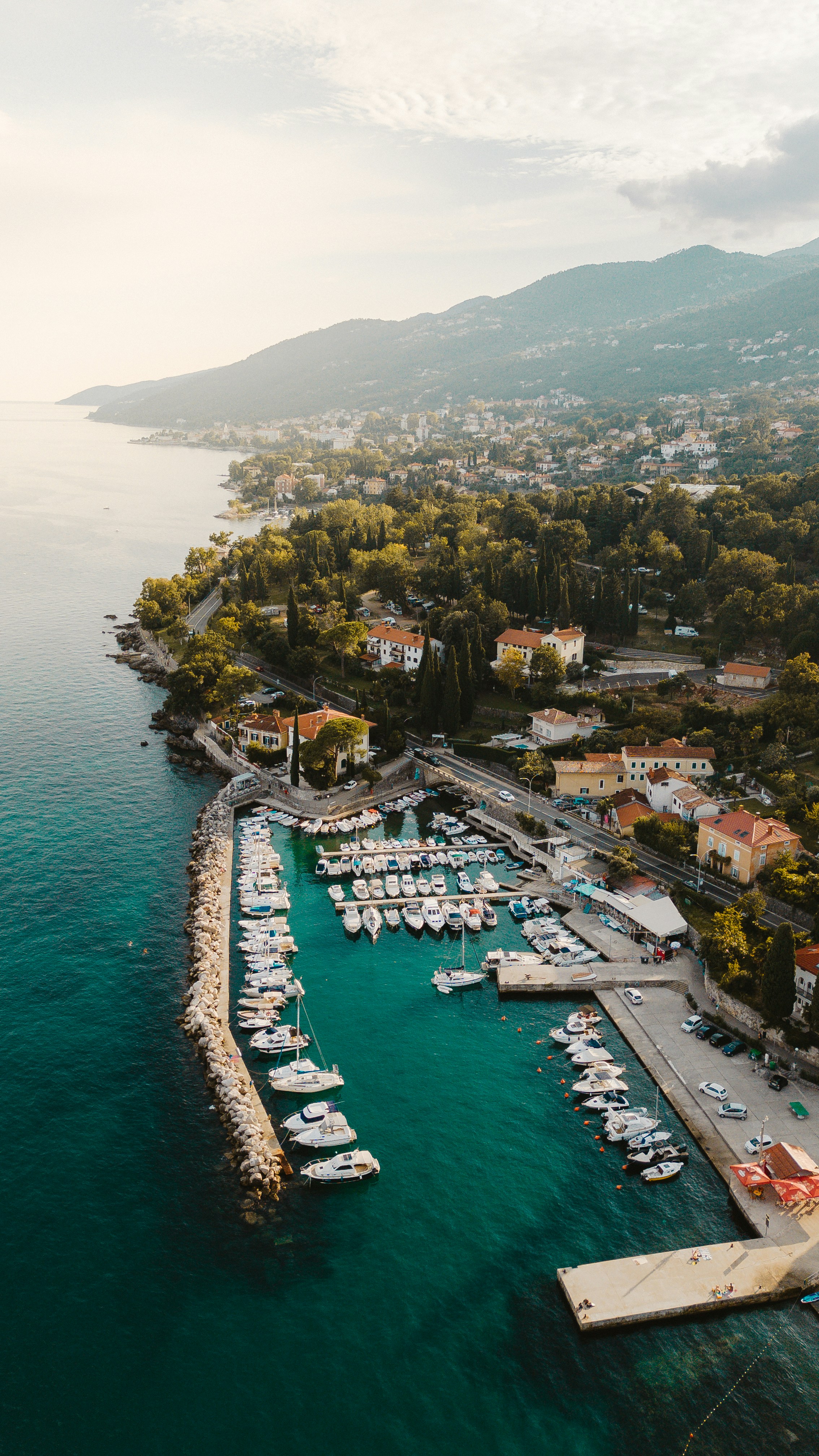 Harbor of Azure Hills: Aerial View of a Mediterranean Marina Framed by Coastal Towns