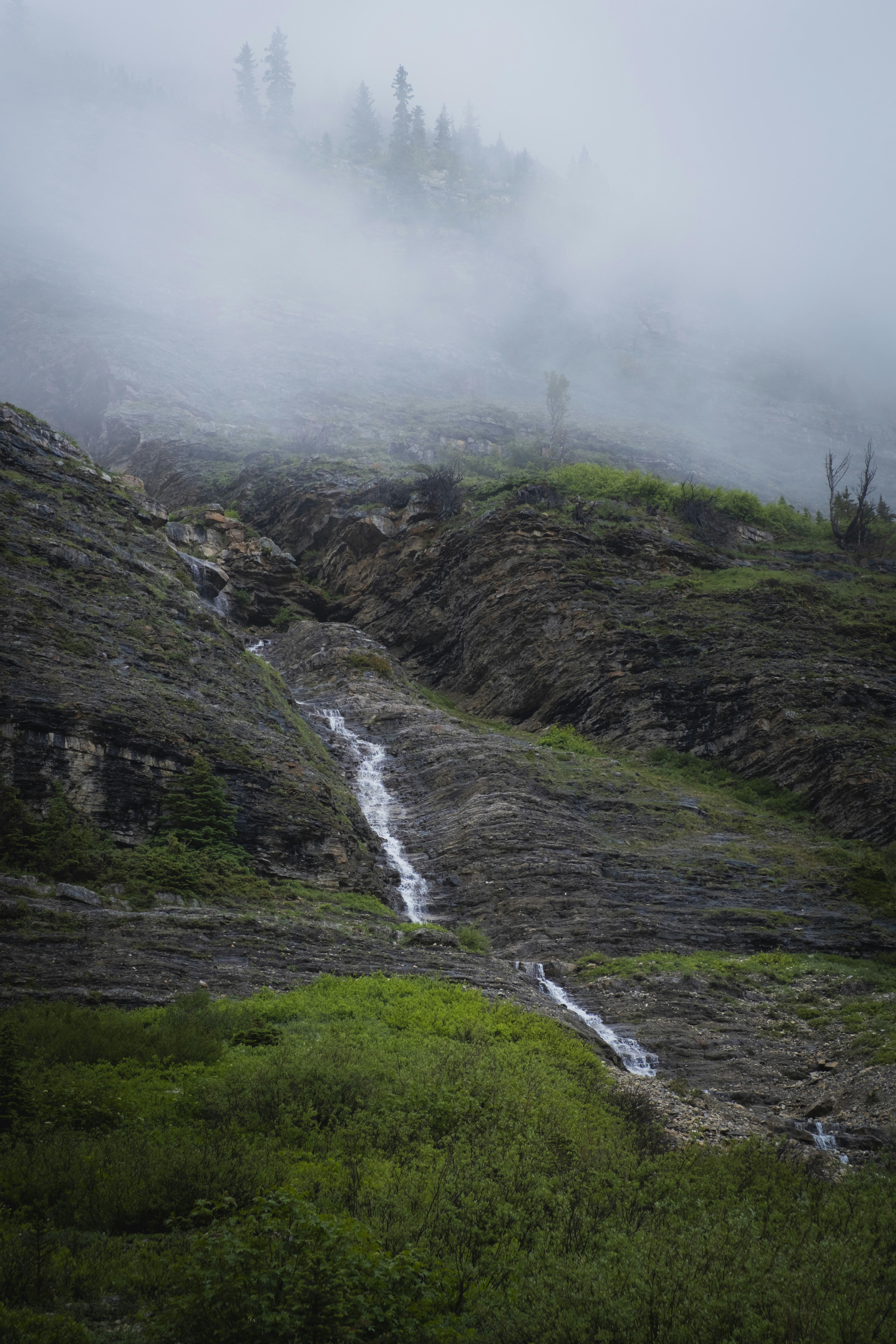 Mist-veil Cascade: A Mountain Creek Carving Through Terraced Rocks