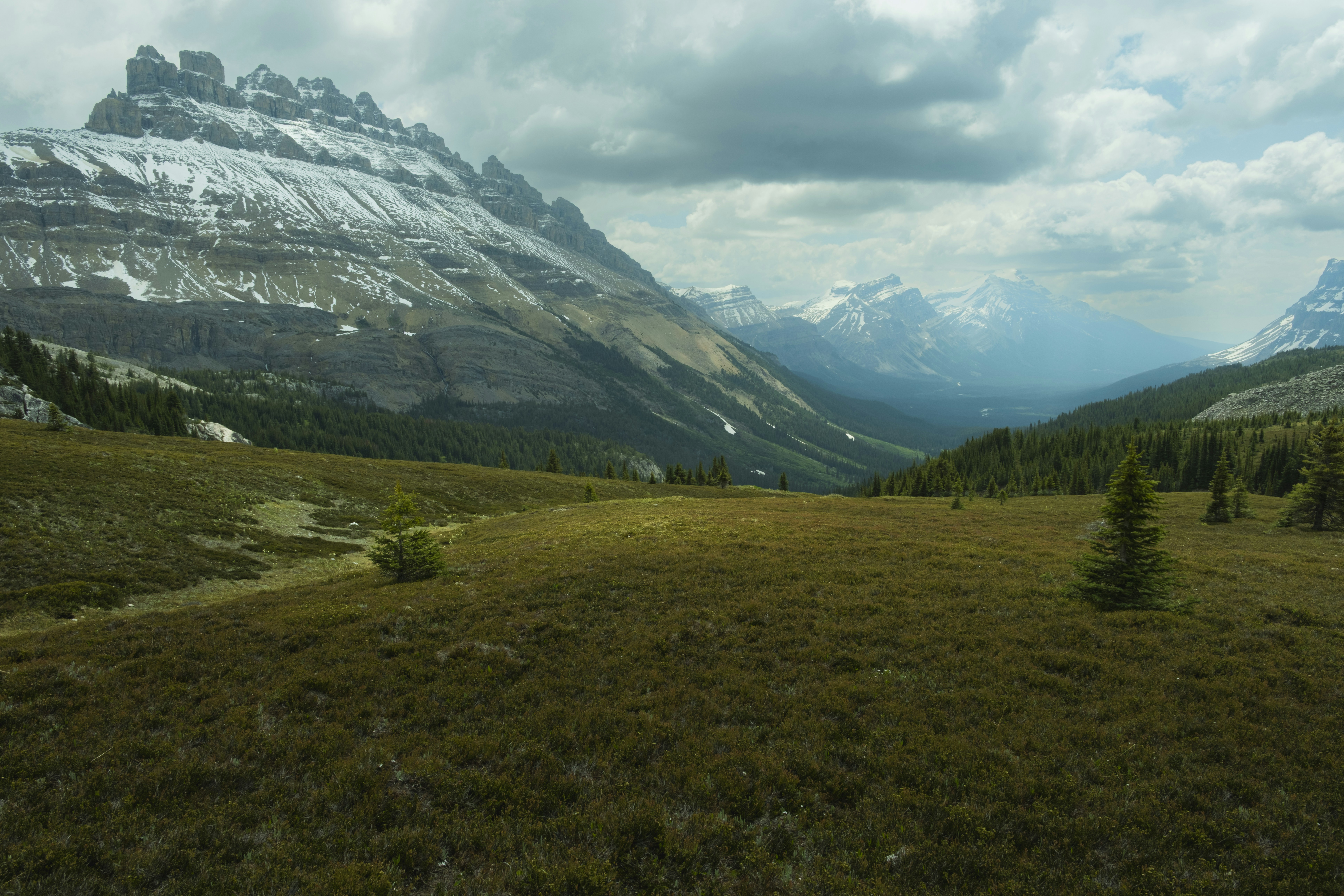 Echoes of the Valley: Snow-dusted Peaks Beneath a Vast Prairie