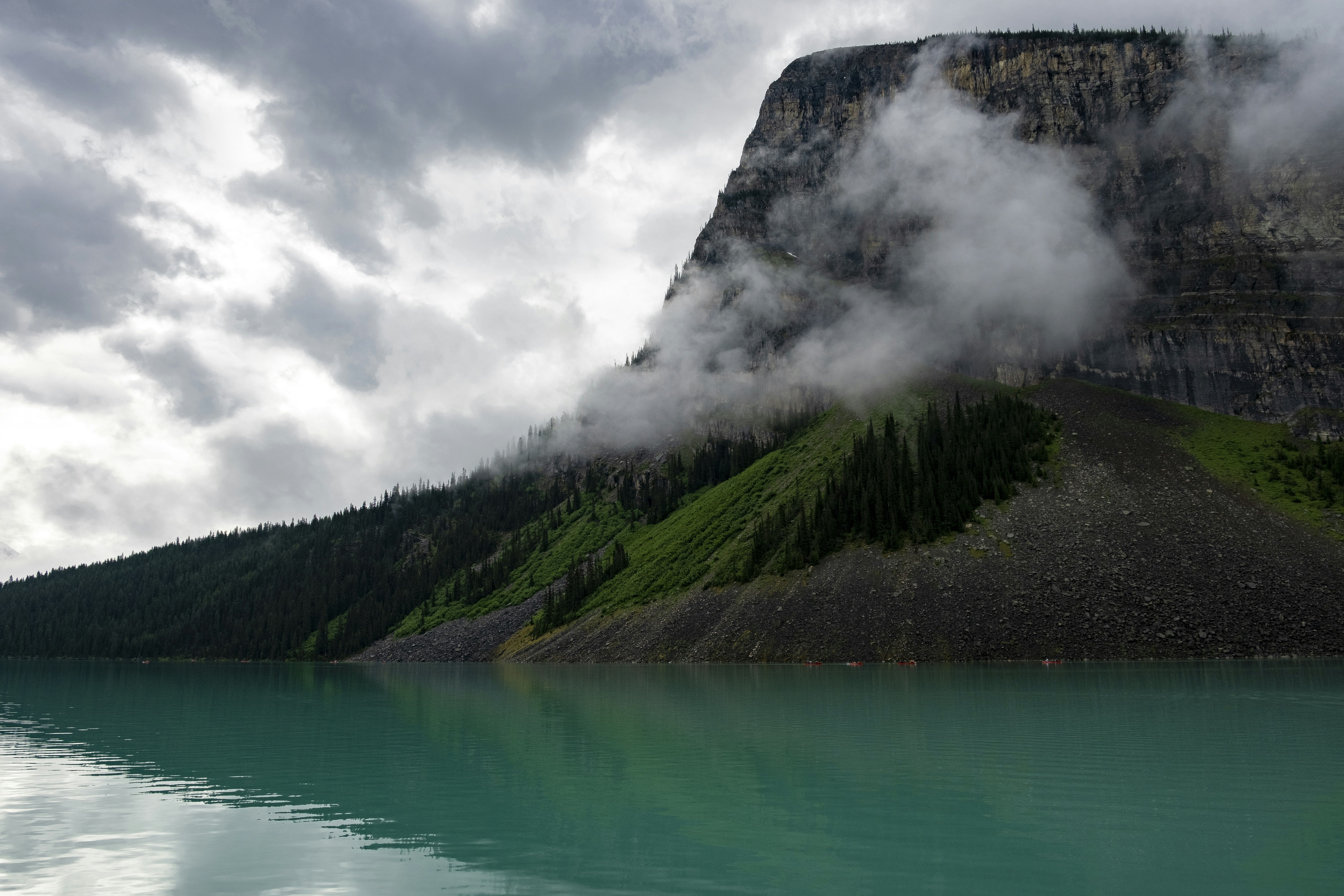 Emerald Caldera: Teal Waters Meet Looming Rock and Mist