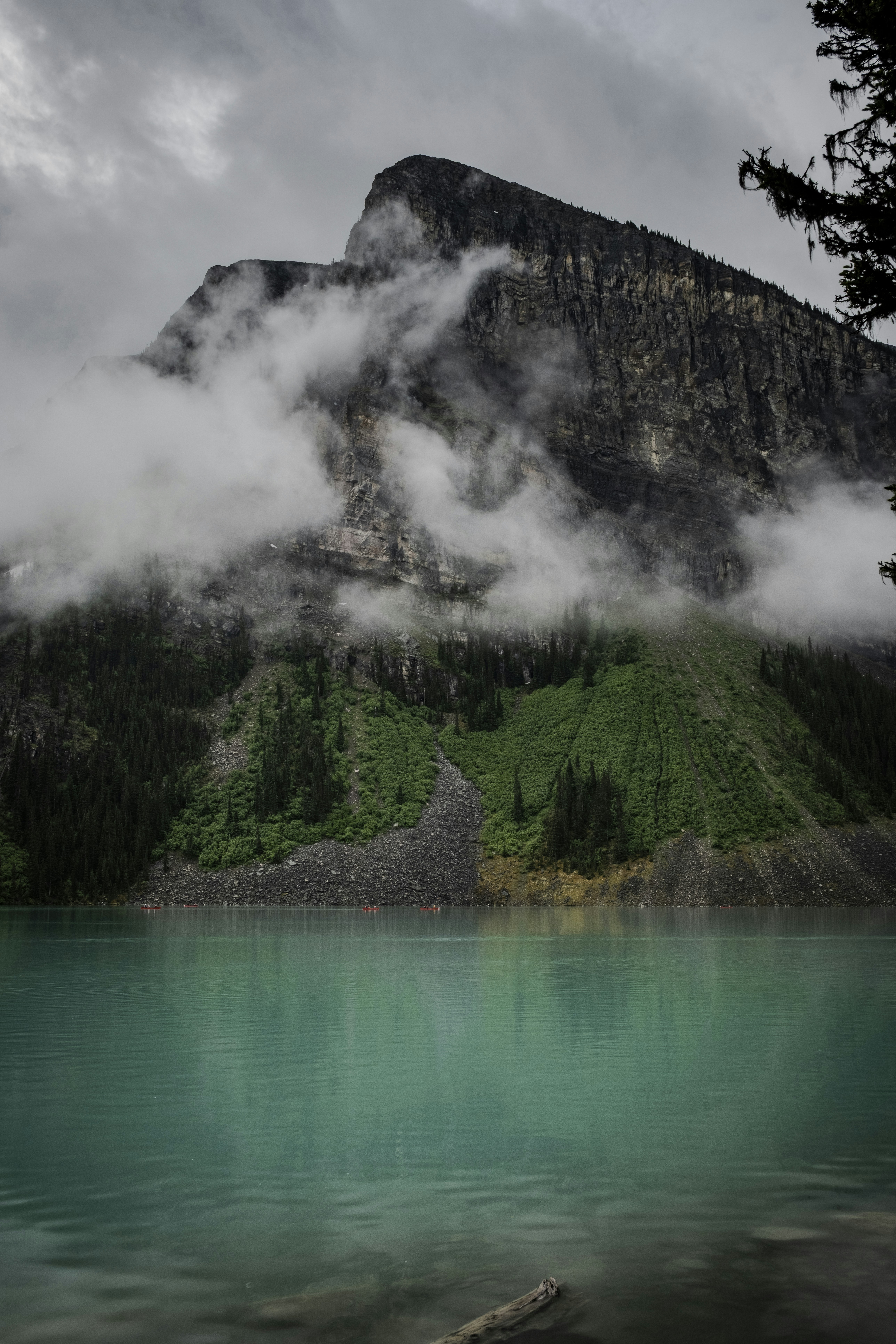 Emerald Mirror: Mountain Lake Beneath a Cloud-veiled Peak