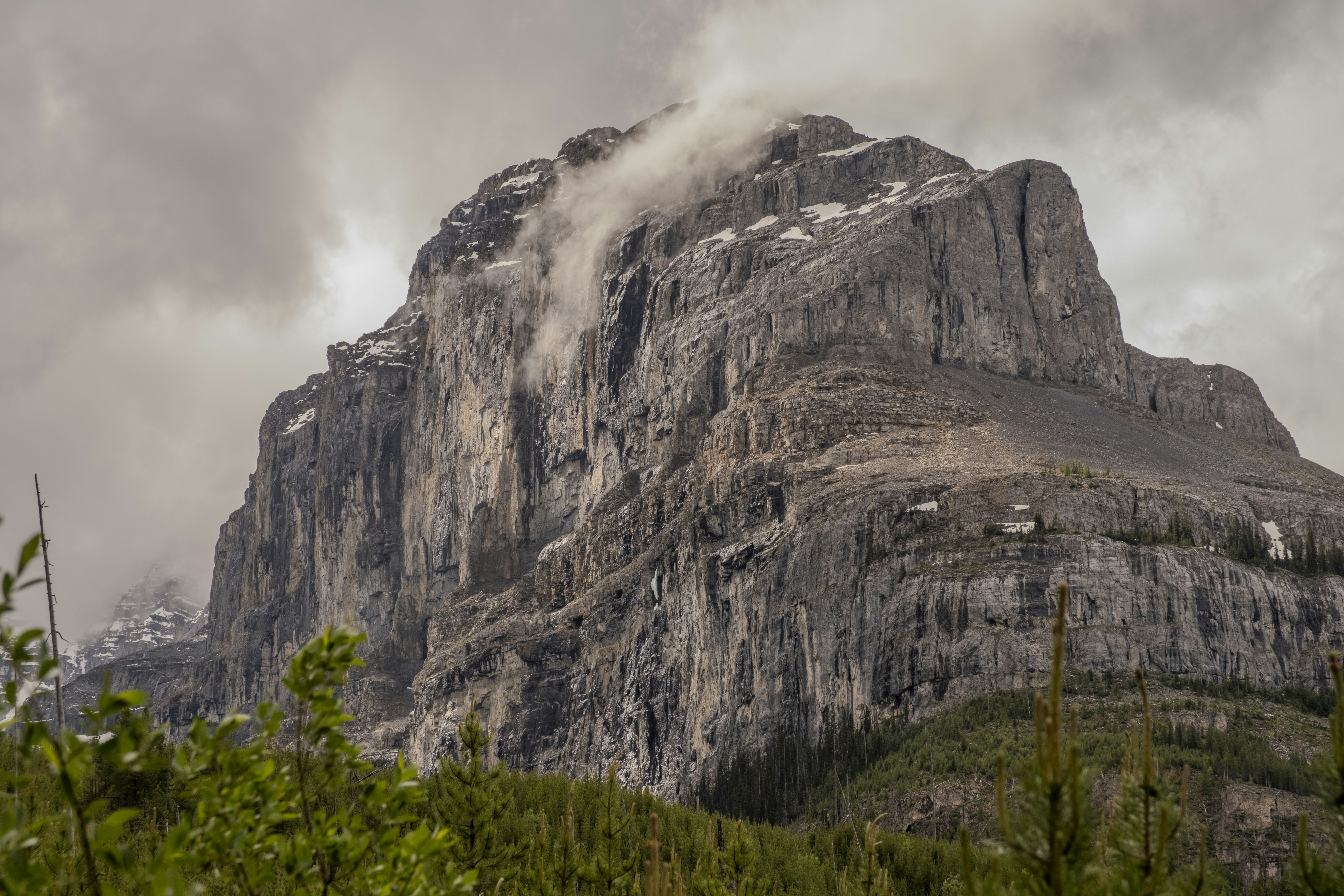Stone Sentinel: A Turreted Peak Reaching Toward a Brume-filled Sky