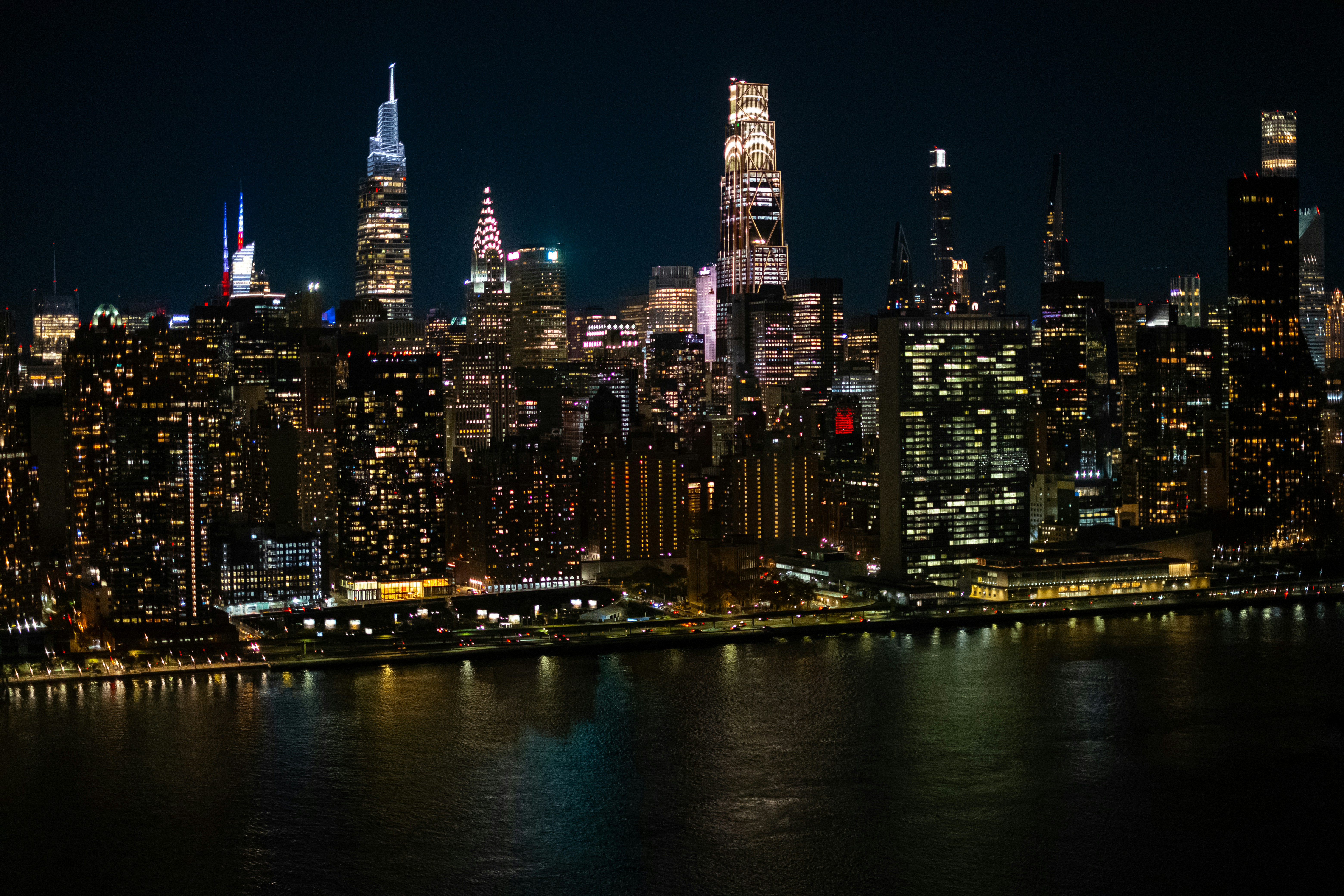 Midnight Riverfront: Neon Skyline Across the Water