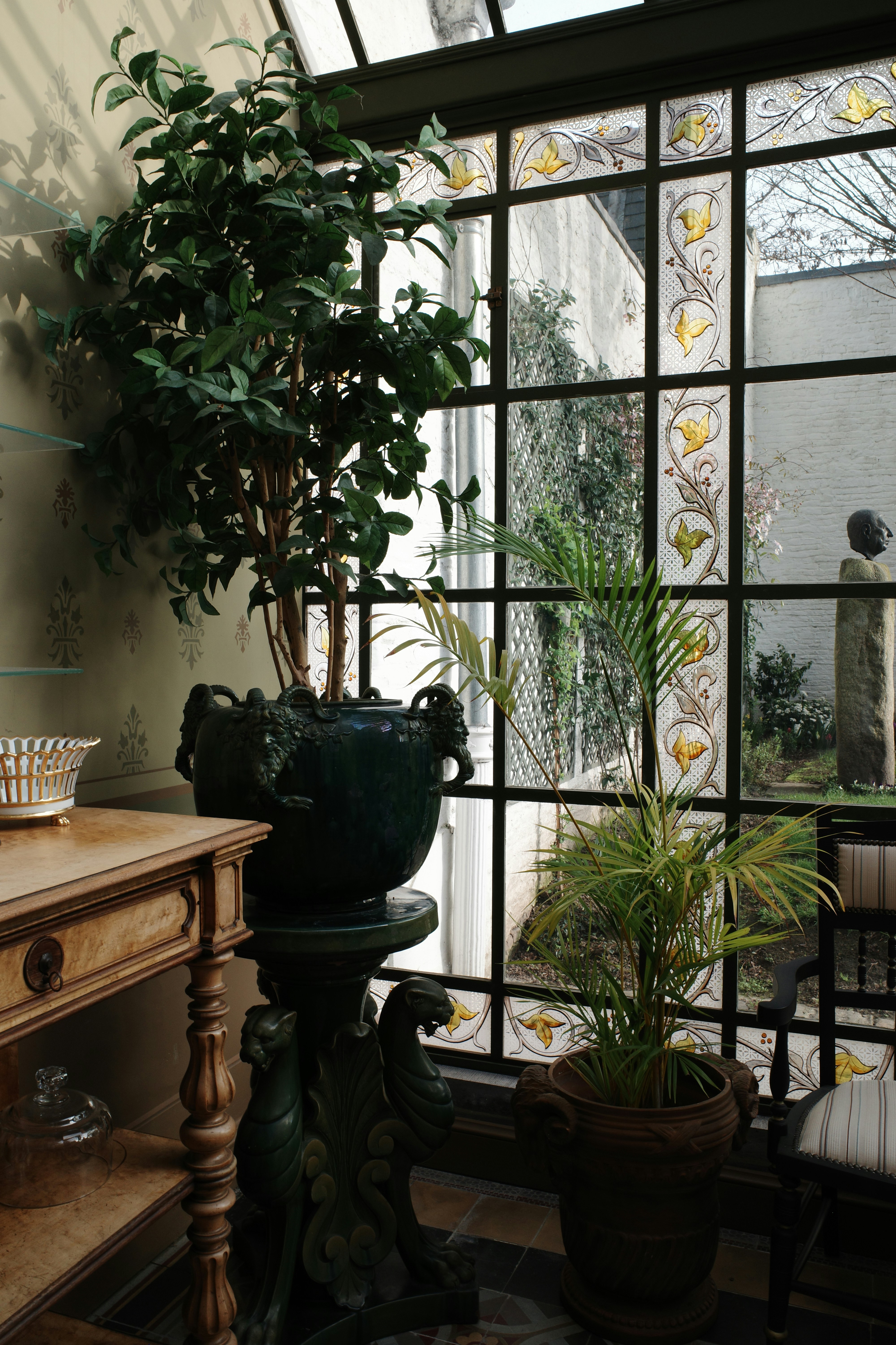 Verdant Corner: Indoor Garden Meets Stained Glass Window