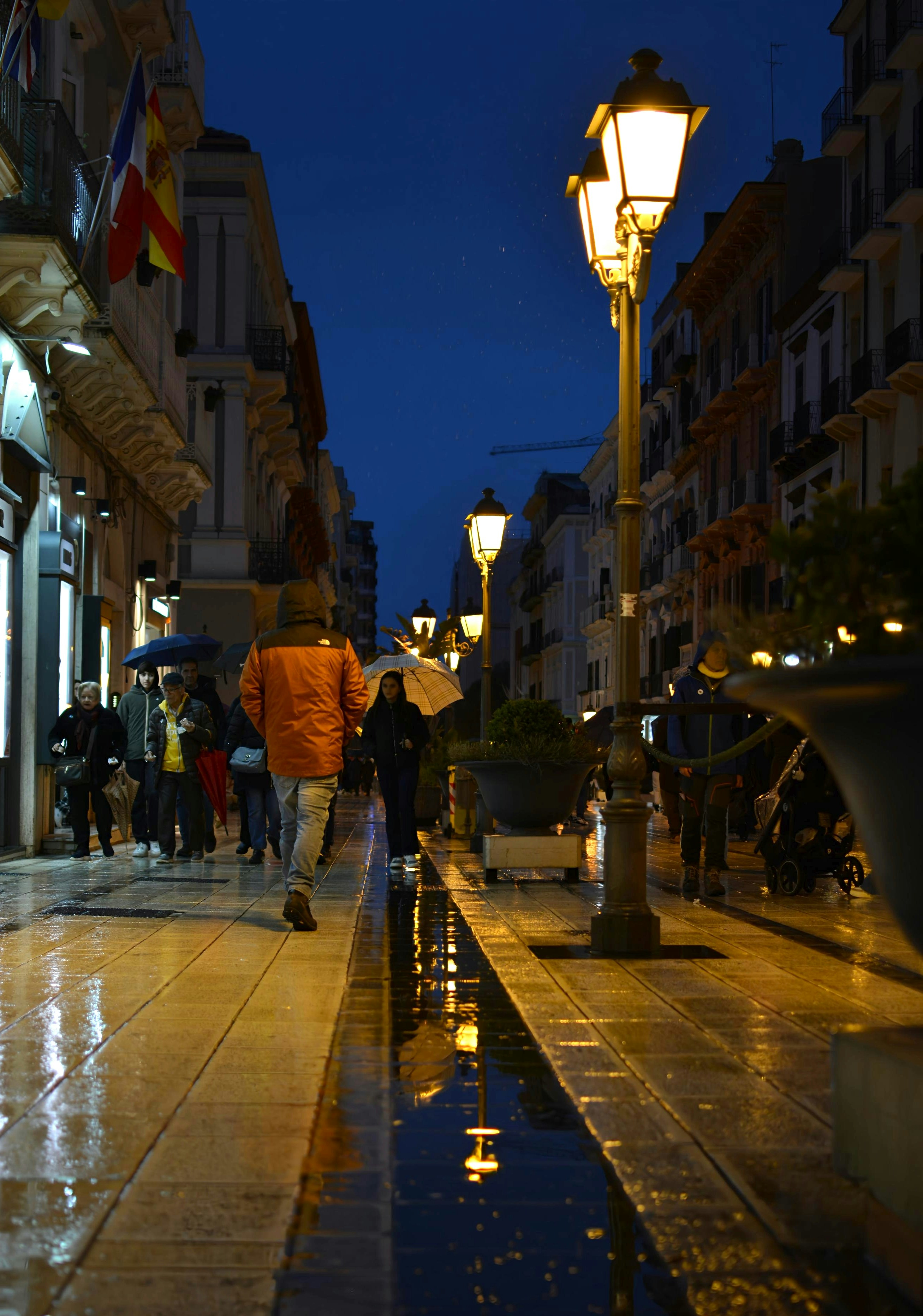 Night Pedestrian Alley with Reflections under Warm Streetlights