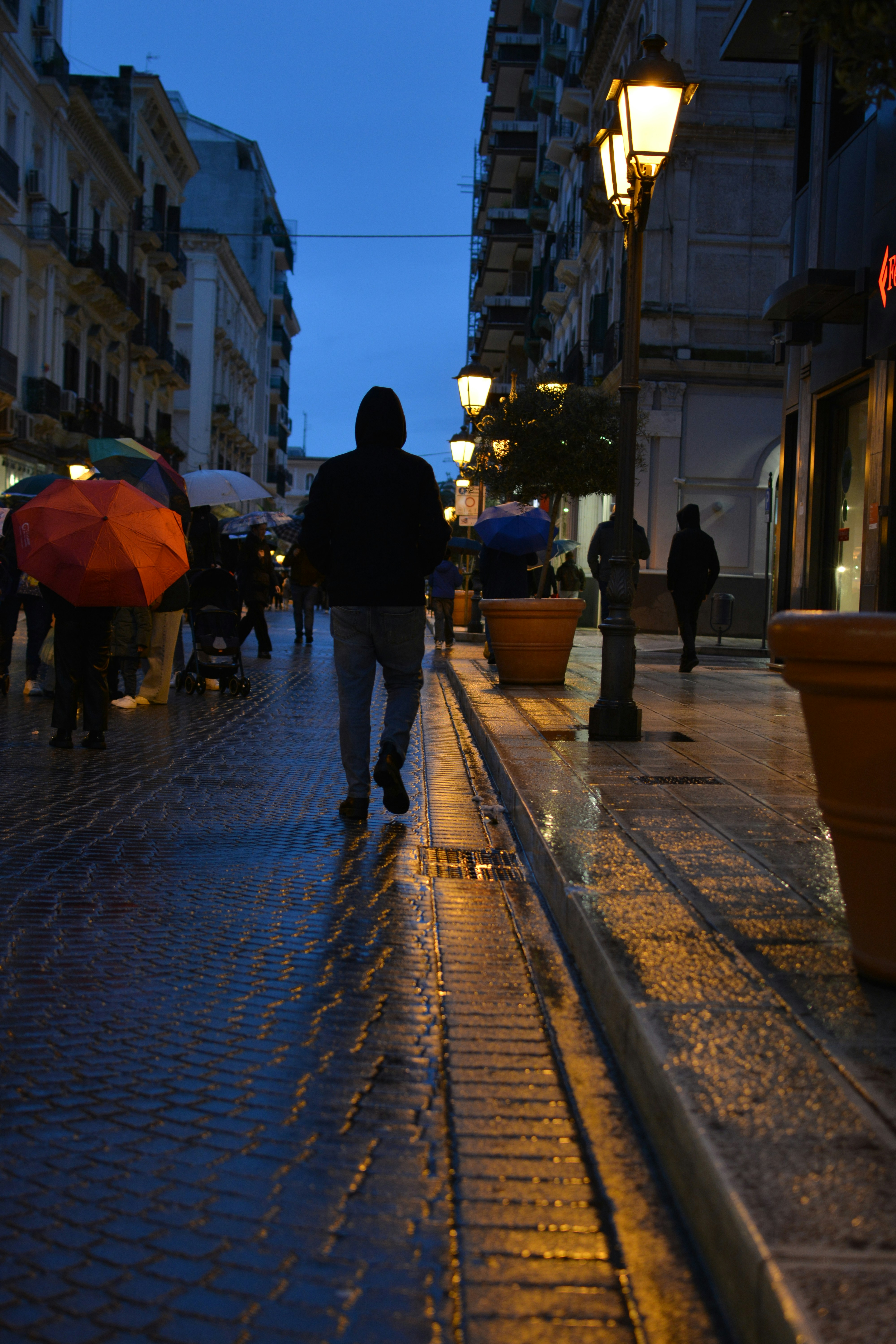Midnight Promenade: A solitary figure in a rain-slick urban glow