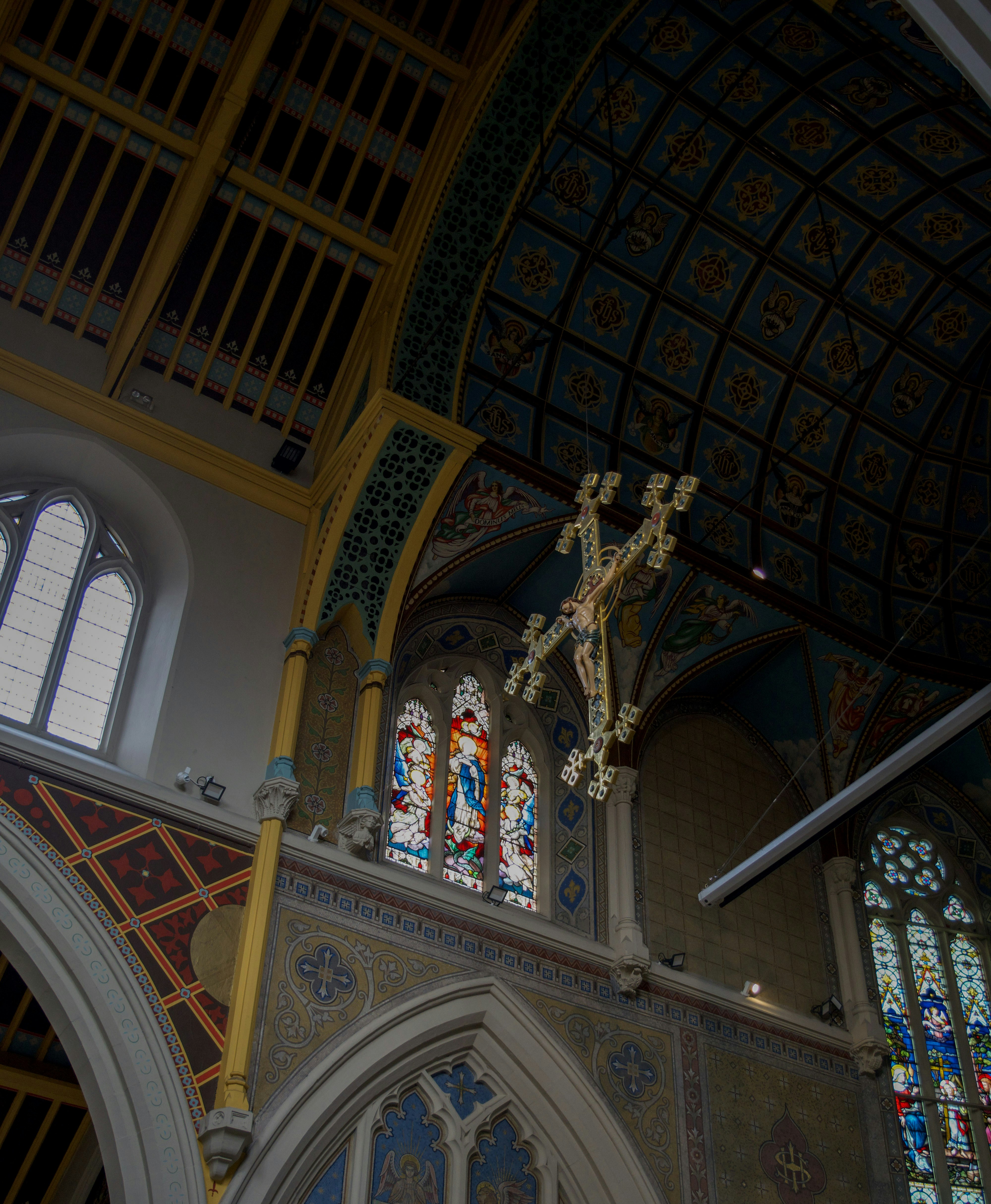 Stained Glass Accent: Gothic Interior beneath a Royal Chandelier