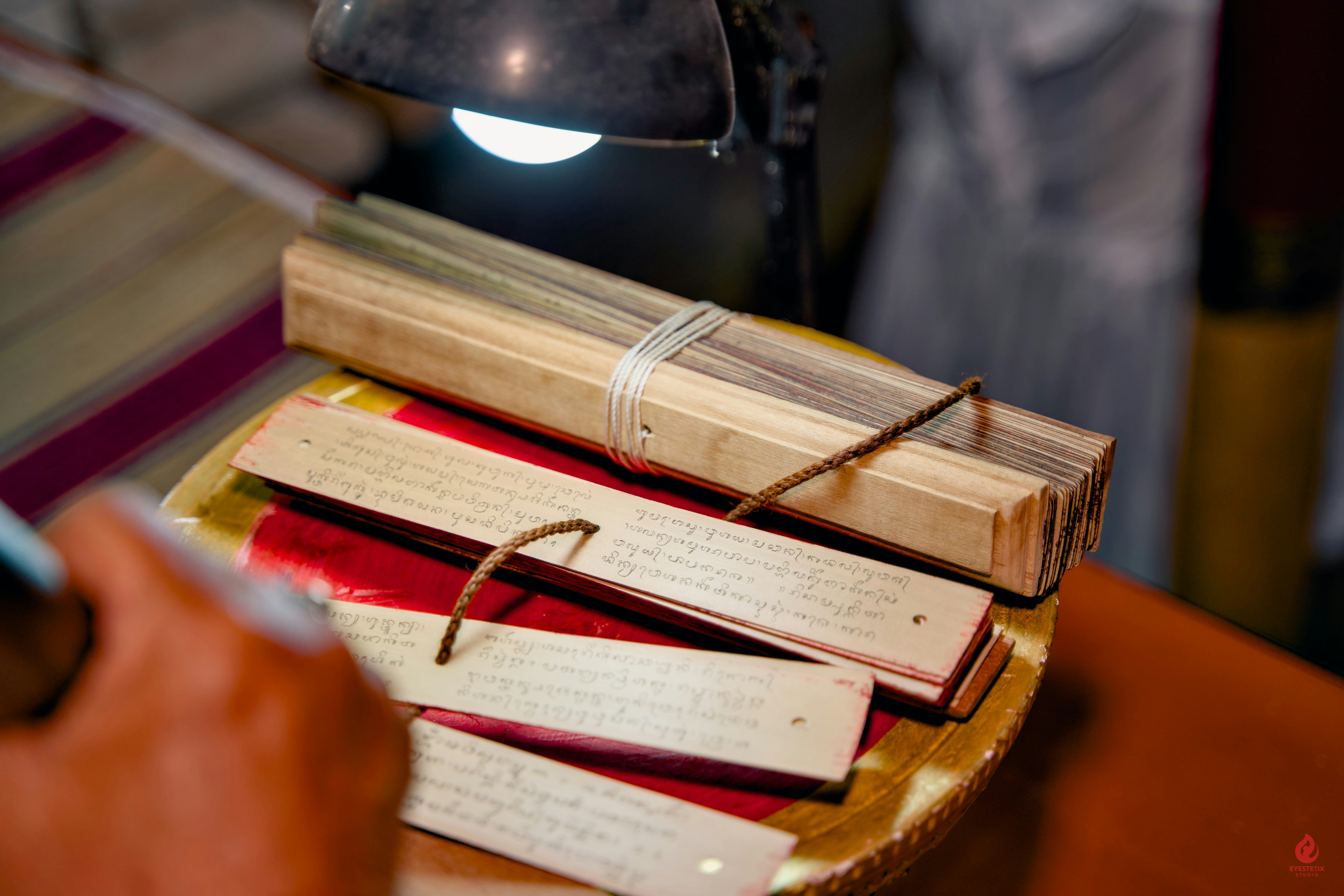 Bundles of time: handwritten notes bound in string under a focused desk lamp