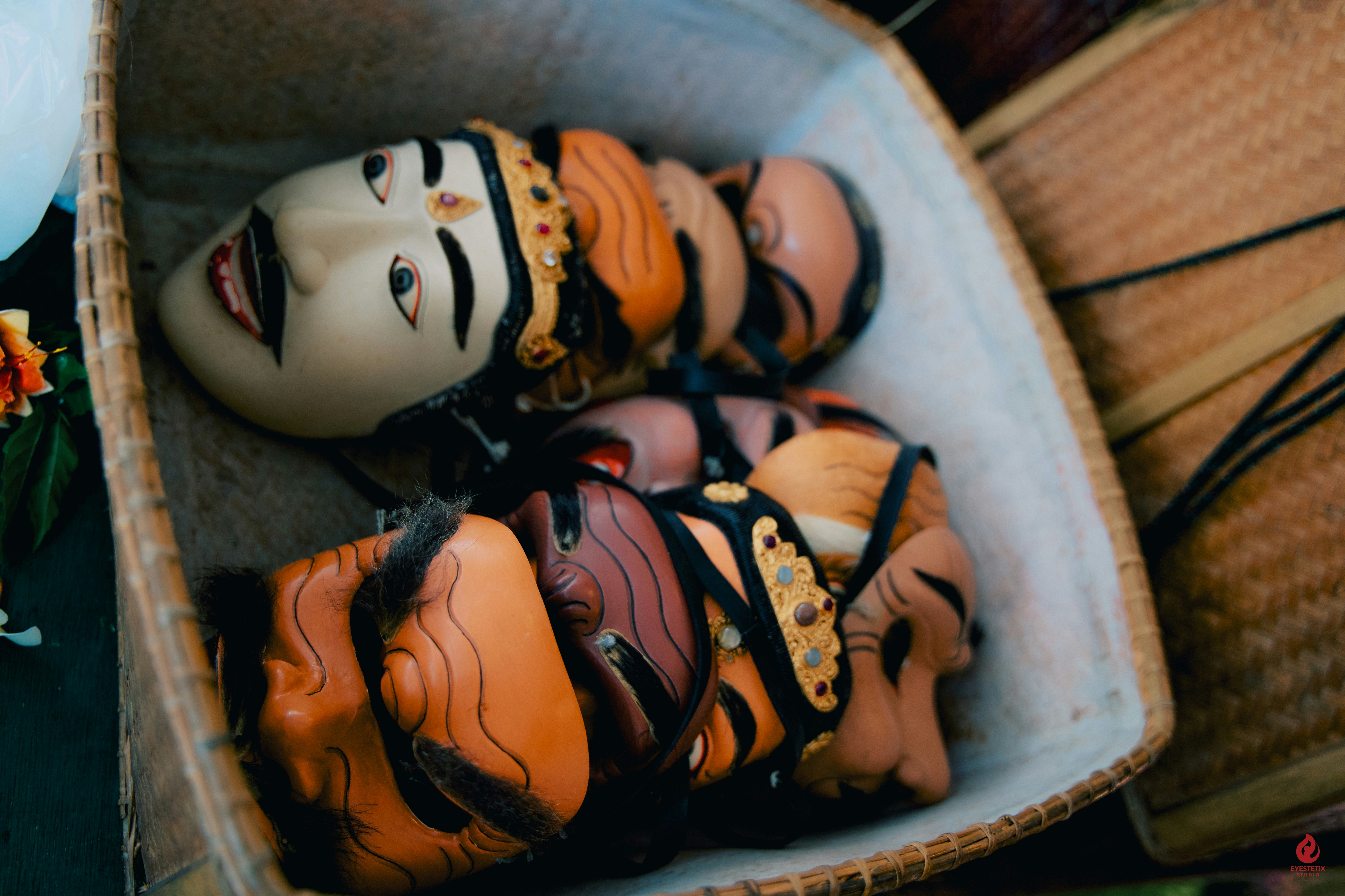 Masks in a Basket: Glazed Faces and Wooden Backdrop