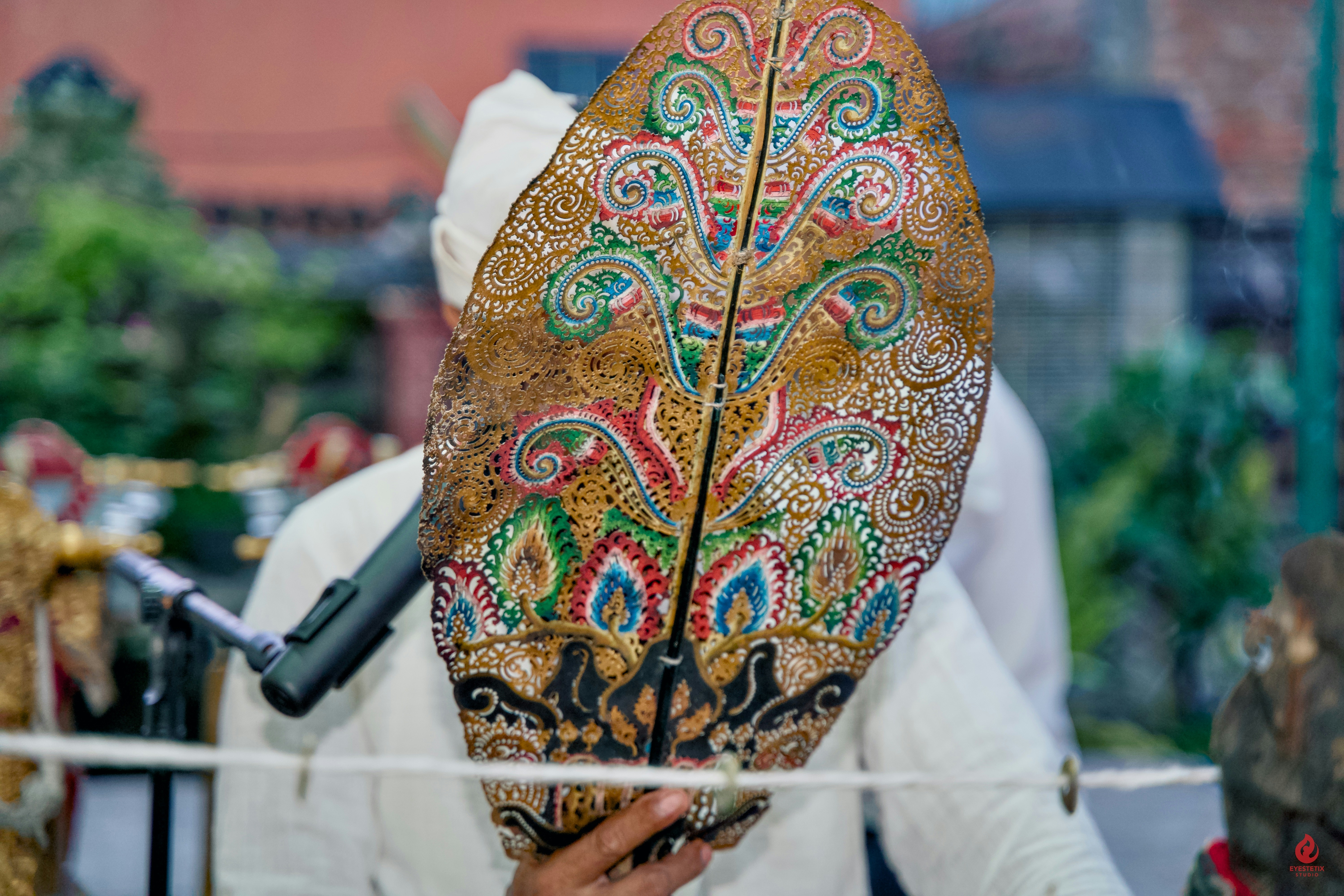 Embroidered Leaf Mask as Centerpiece at a Cultural Gathering