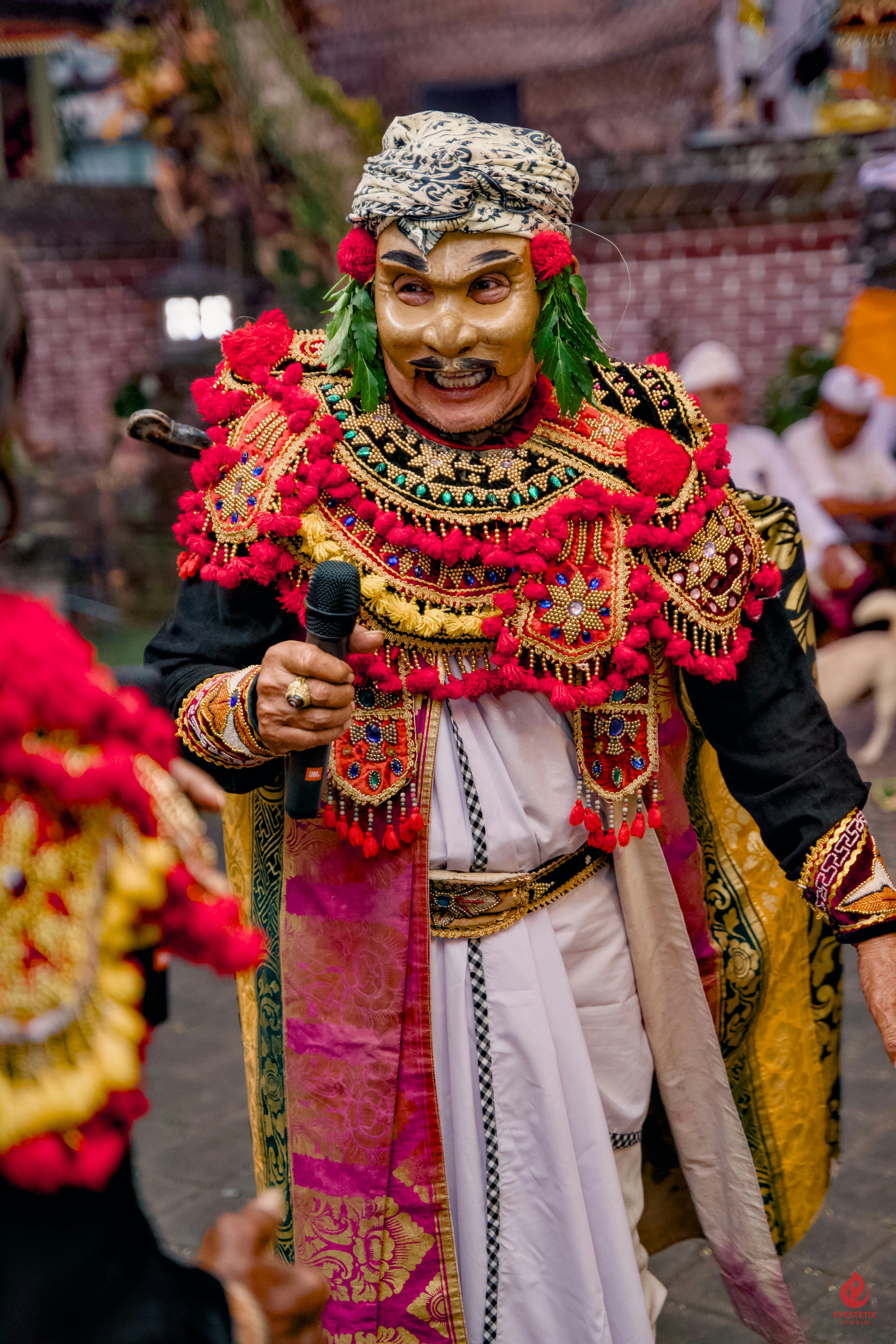 Vibrant Masquerade: A Bold Masked Performer in Ornate Adornments