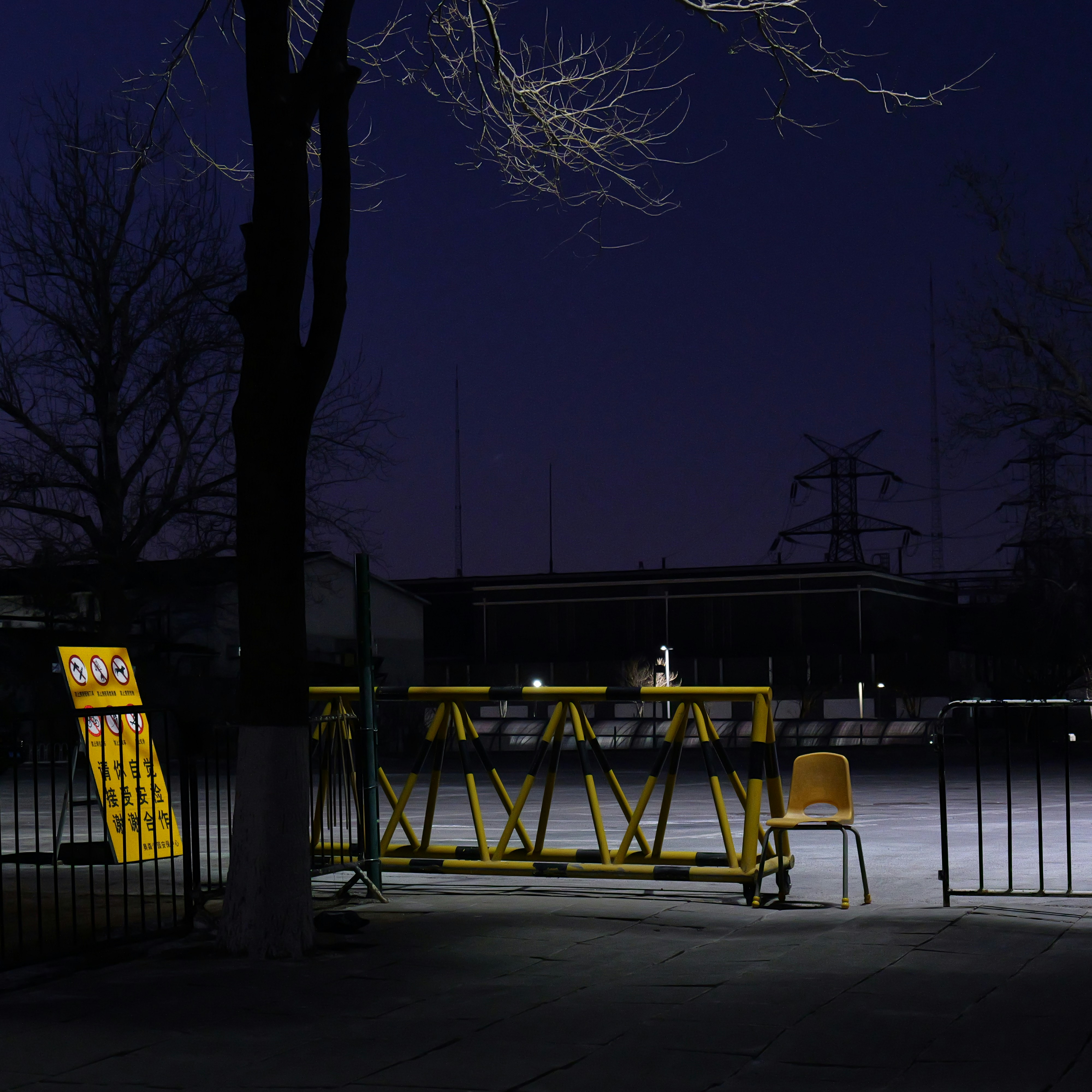 Night Fence: Quiet Barriers Under a Dim Urban Sky