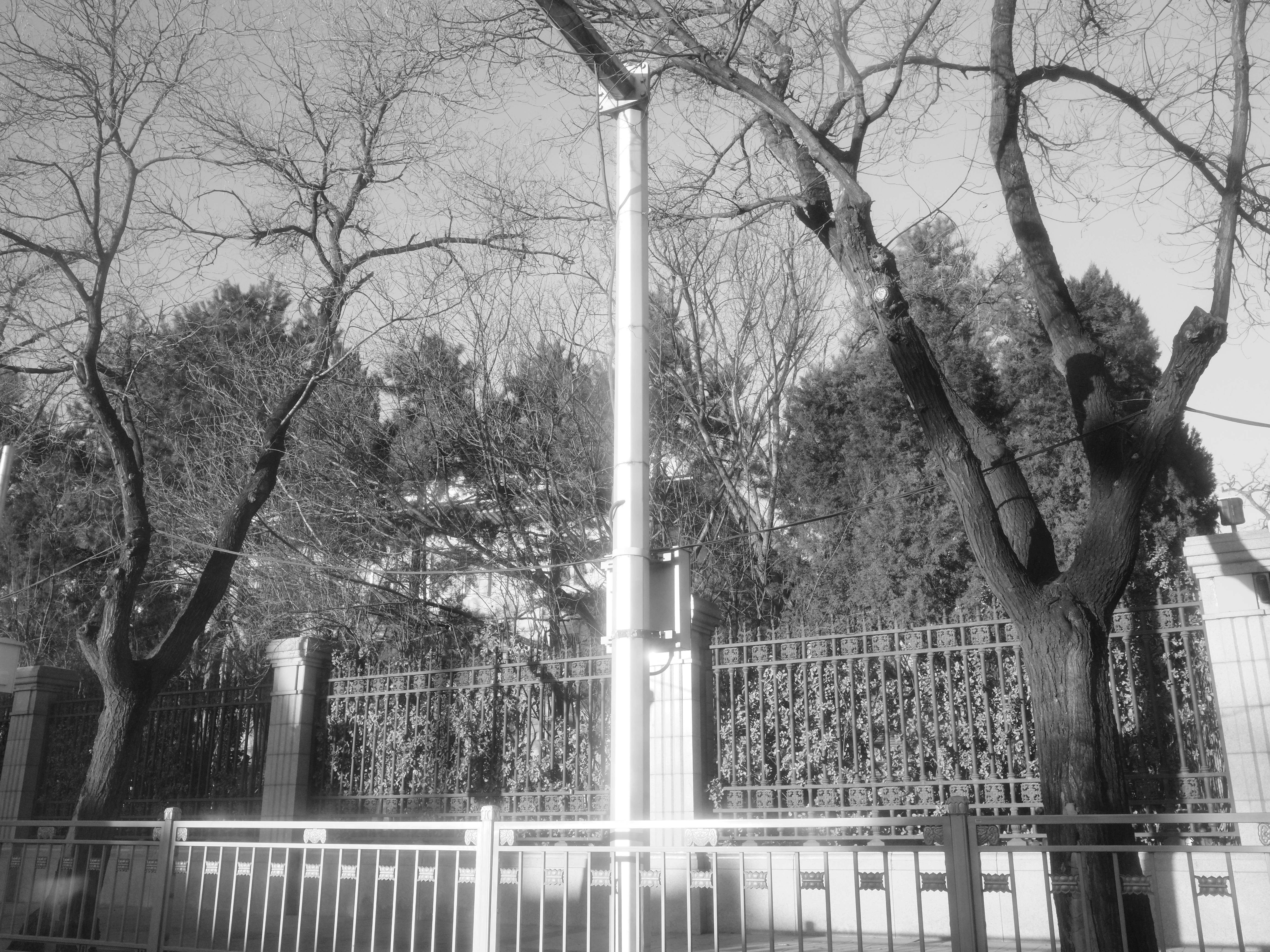 Urban Gateway at Dusk: Monolithic Pole Amid Staircase Railings