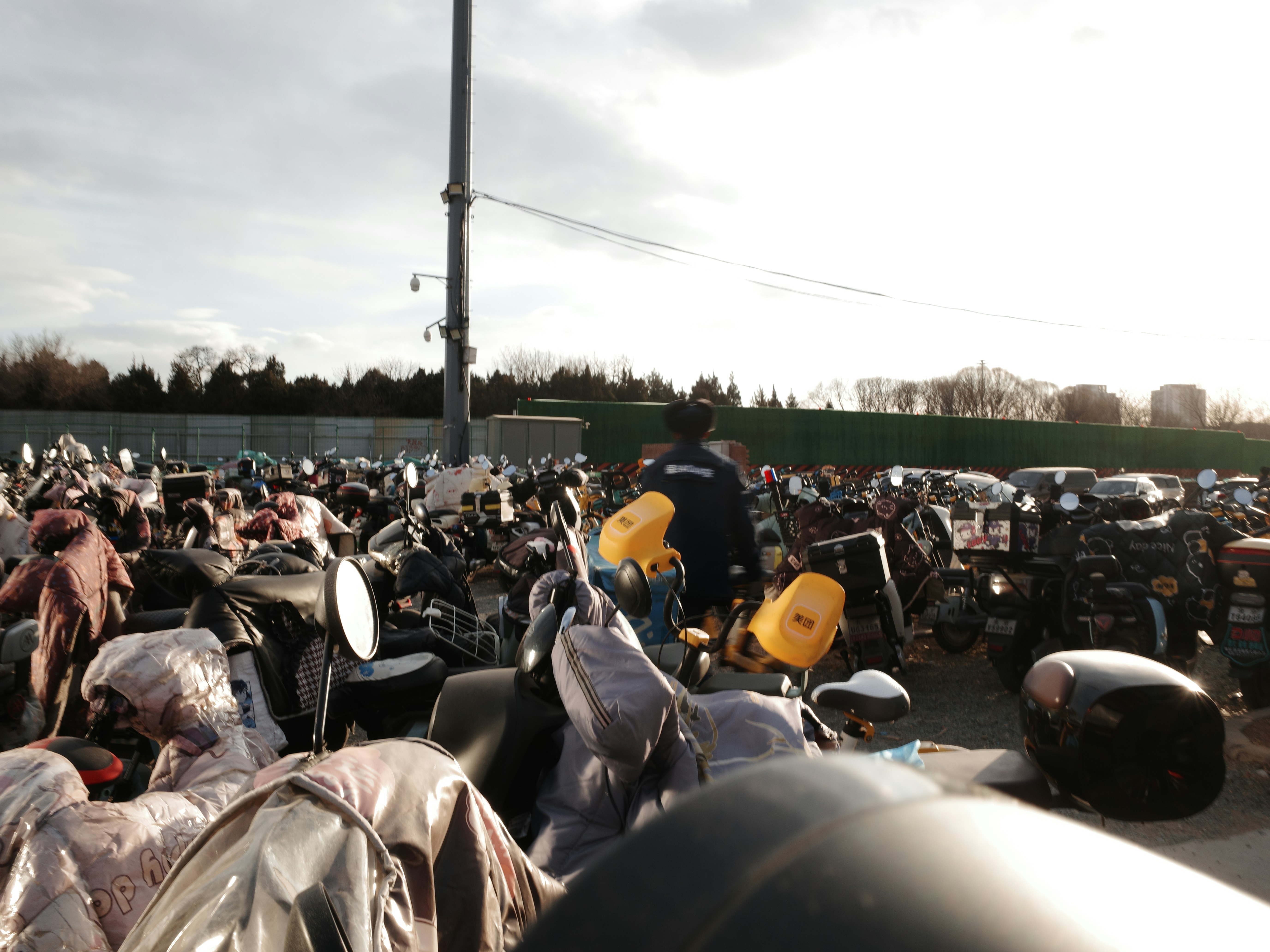 Sunlit Field of Worn Motorcycles at Dusk