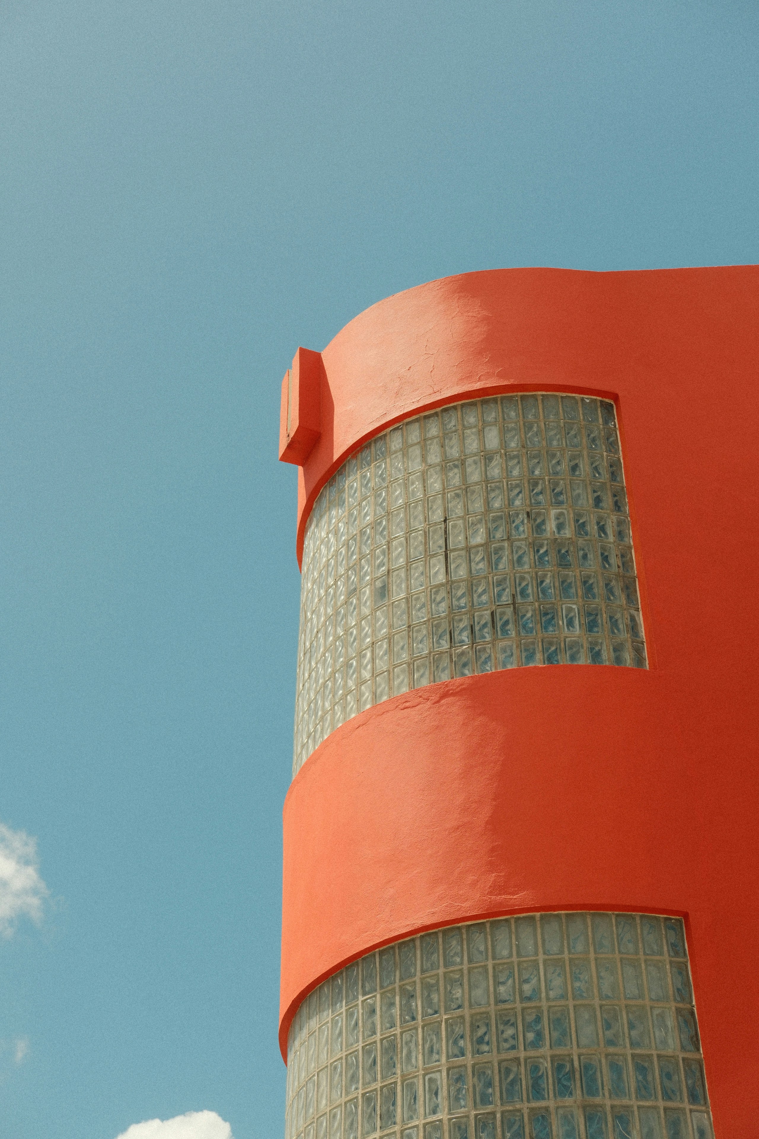 Orange Cylinder at Dusk: A Modern Facade Against Sky