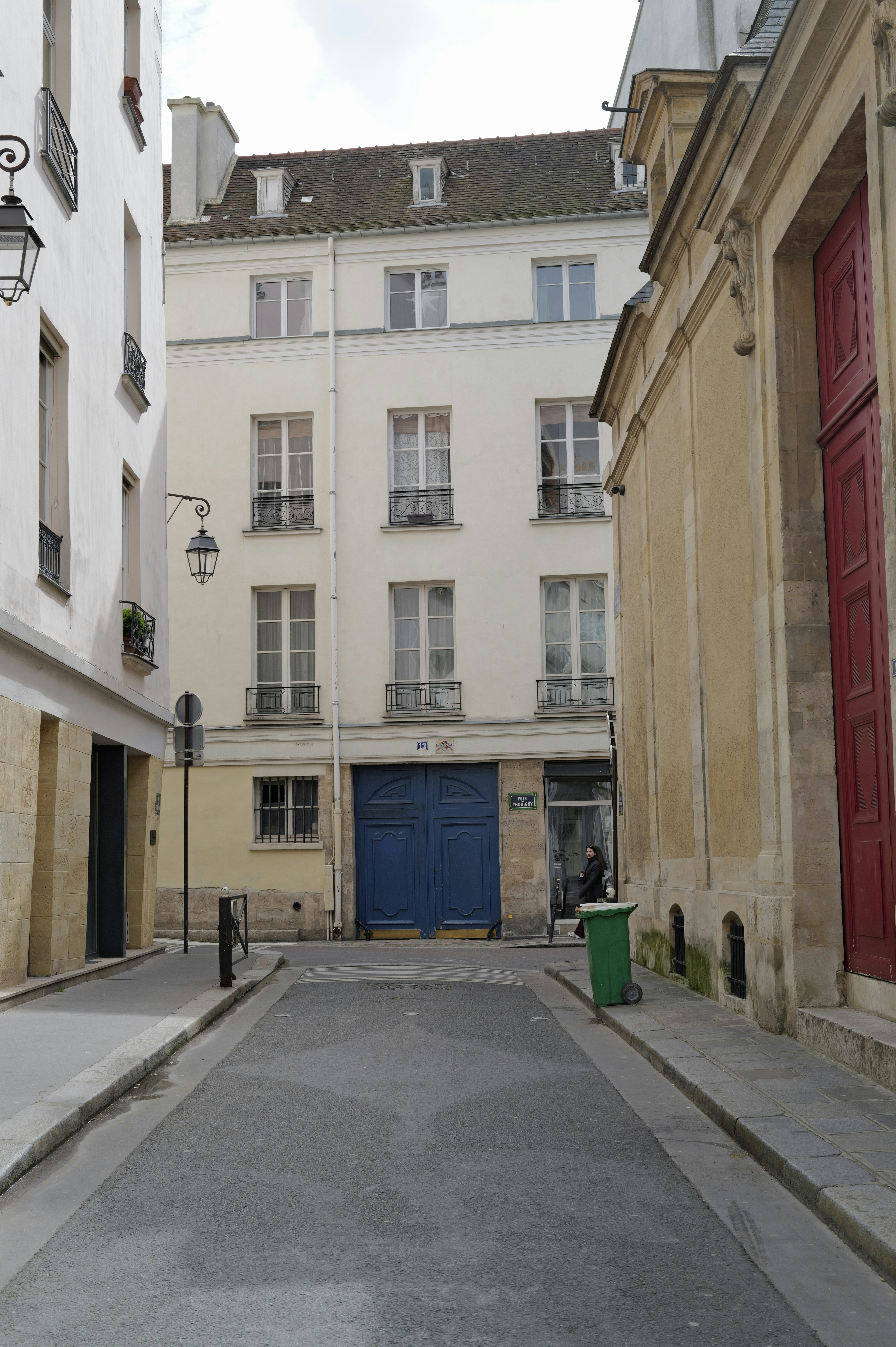 Blue door doorway at the end of a quiet Parisian street