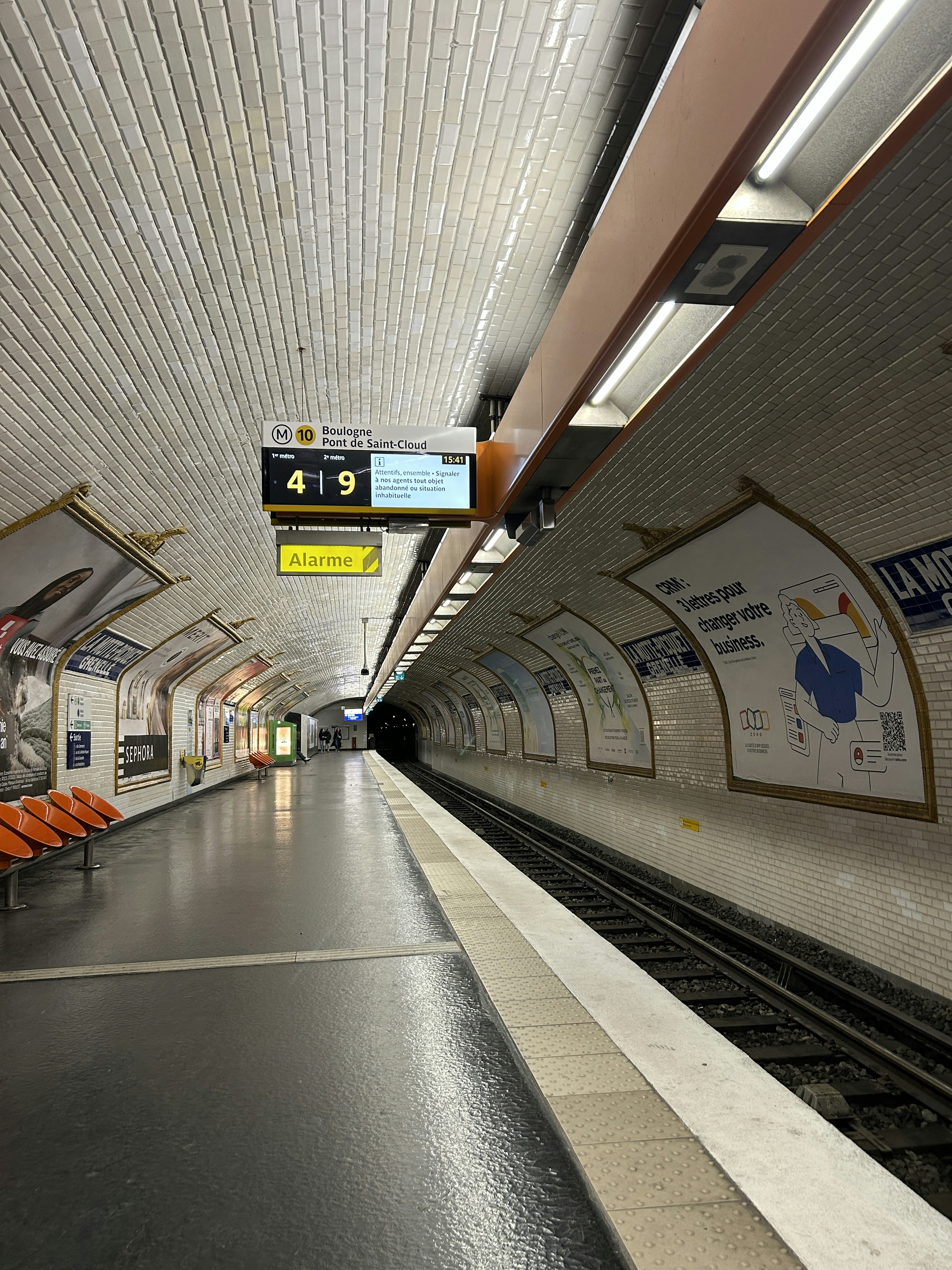 Subway Platform Alone: Overhead Tunnel Lights Recede into Darkness