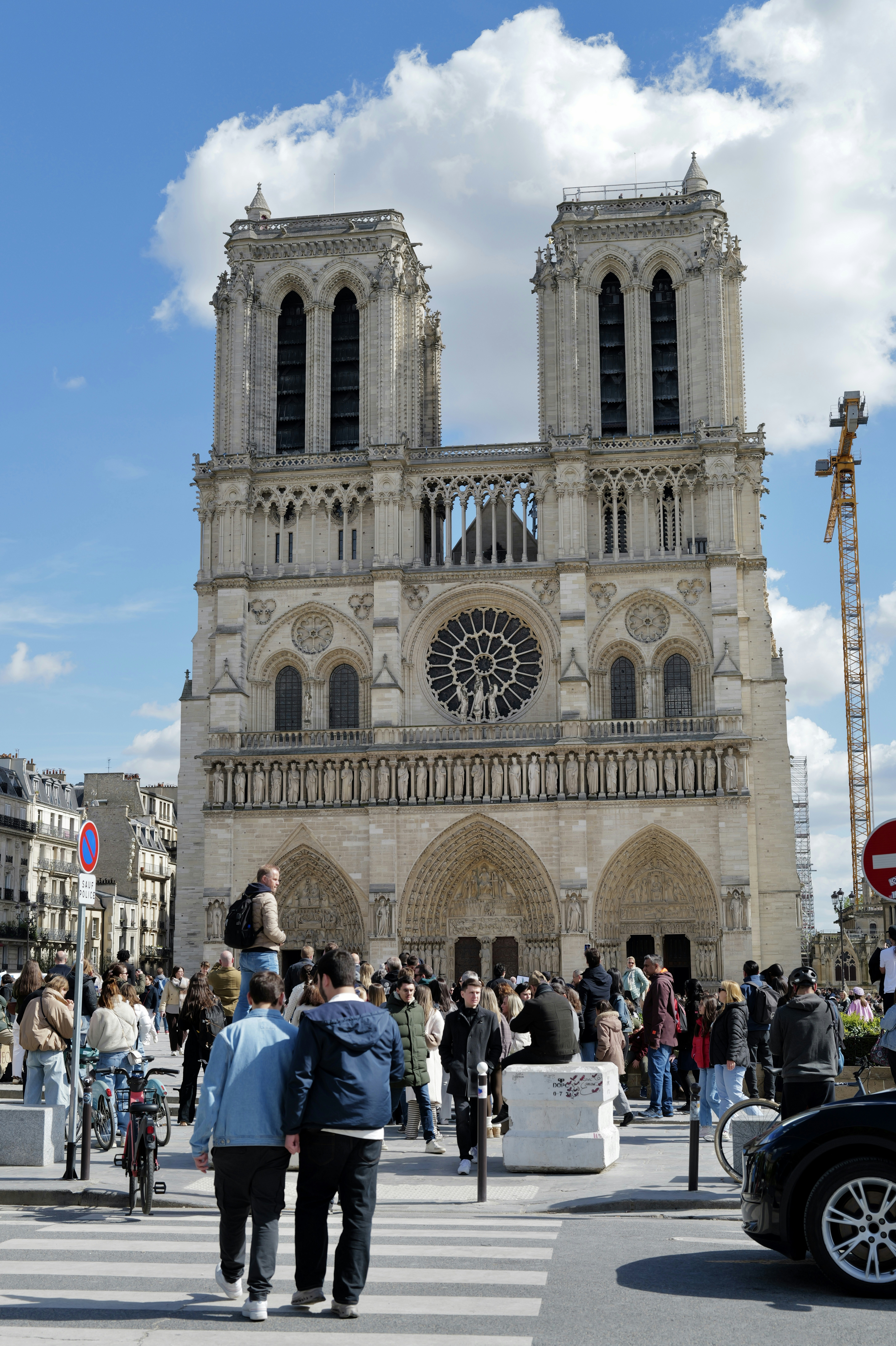 Notre-Dame in Focus: Crowds Beneath the Facade