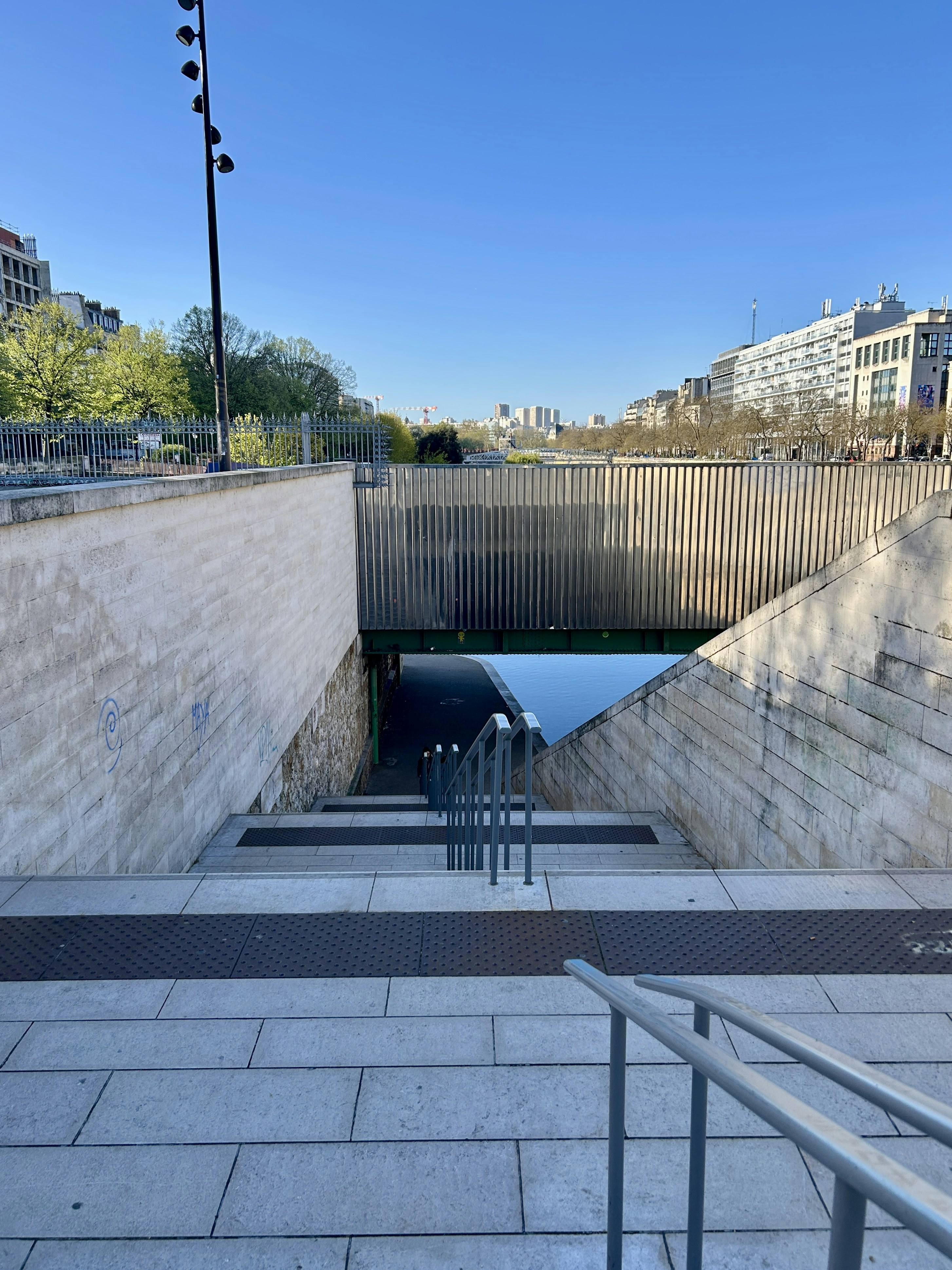 Urban Descent: Concrete Staircase Framing a Quiet City Underpass