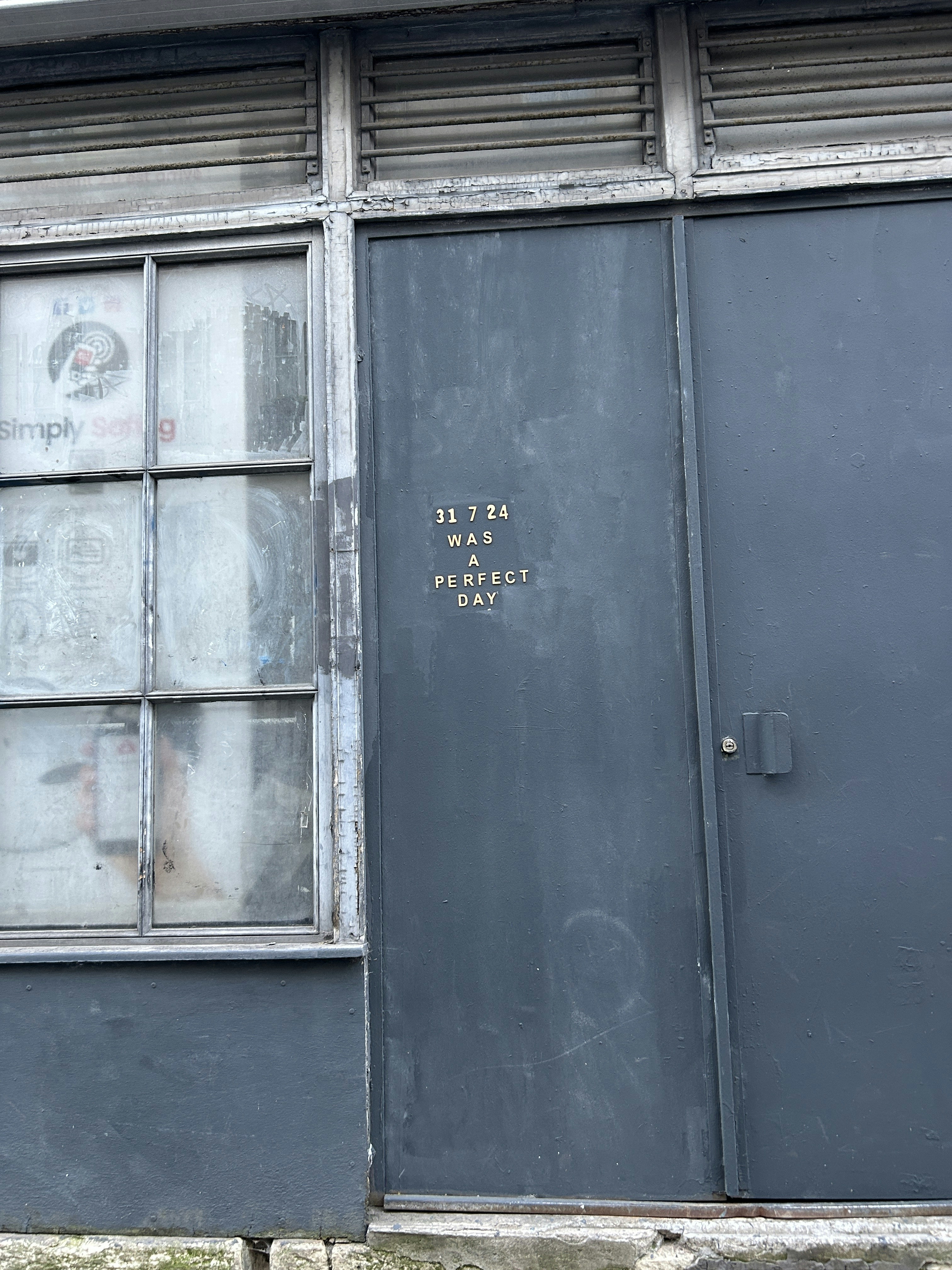 Weathered Blue Doorway with Stenciled Markings