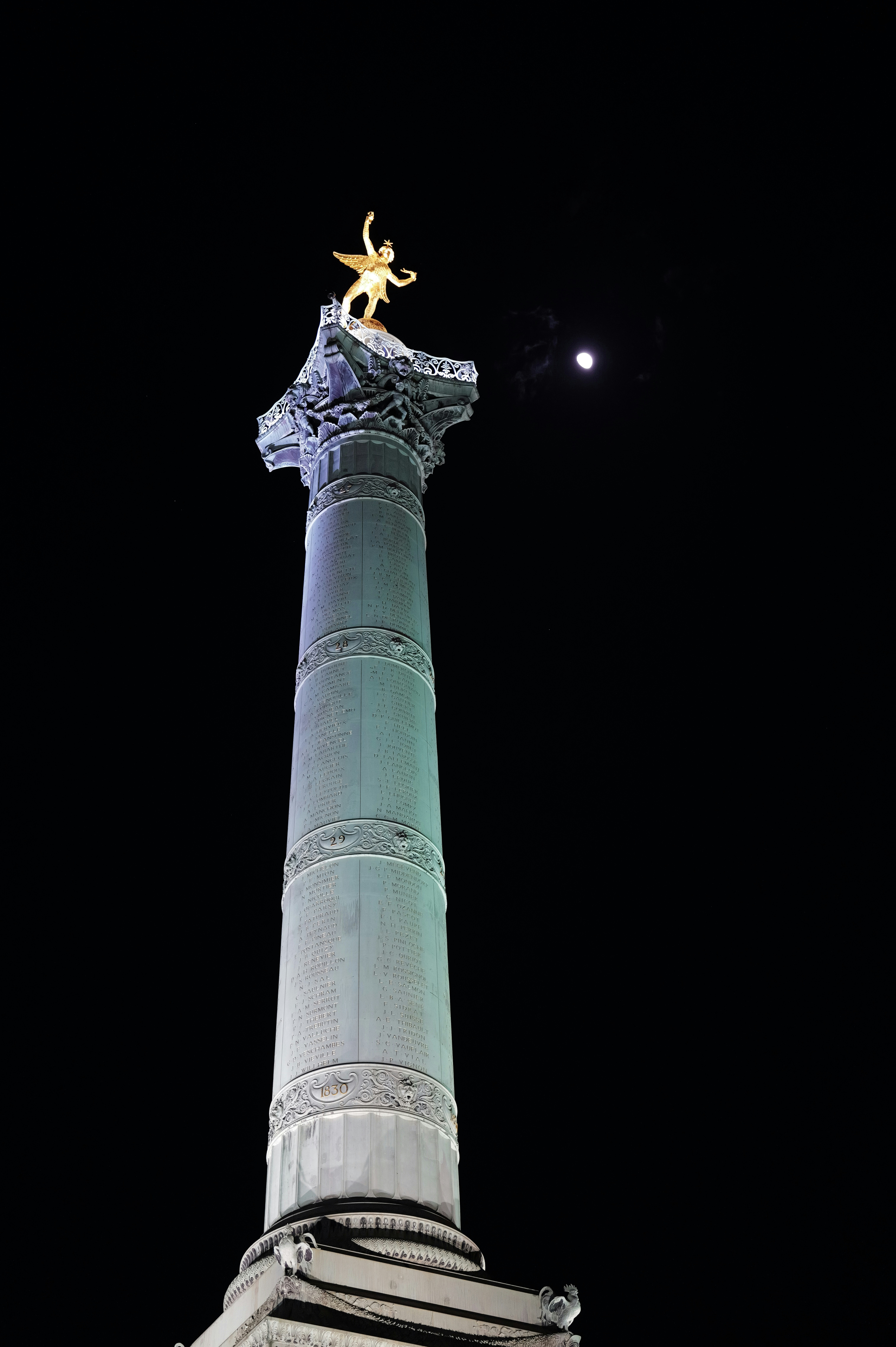 Moonlit Guardian: A Statue Crowned Towered Above the Night