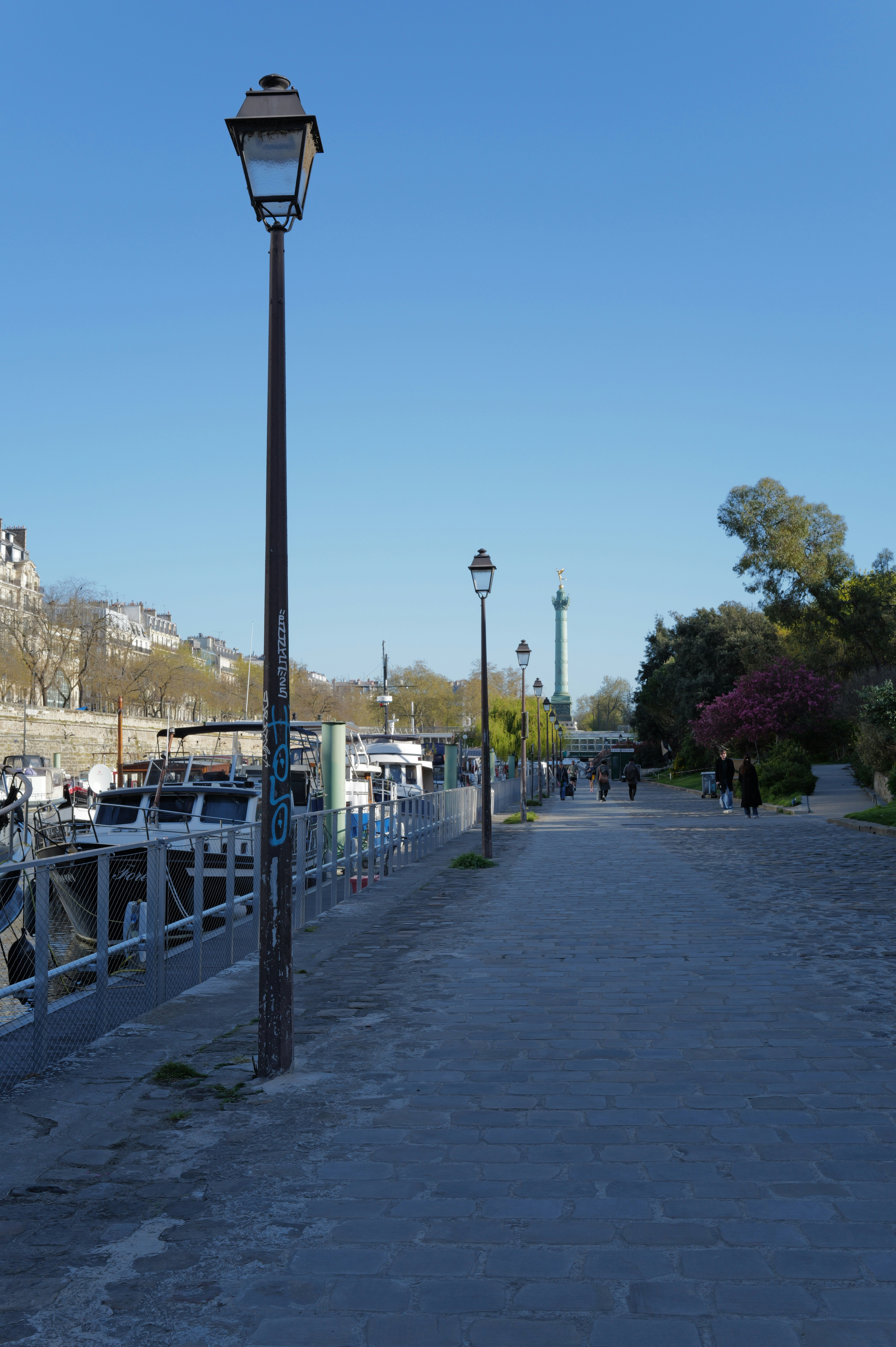Lined Riverwalk Under a Clear Parisian Sky