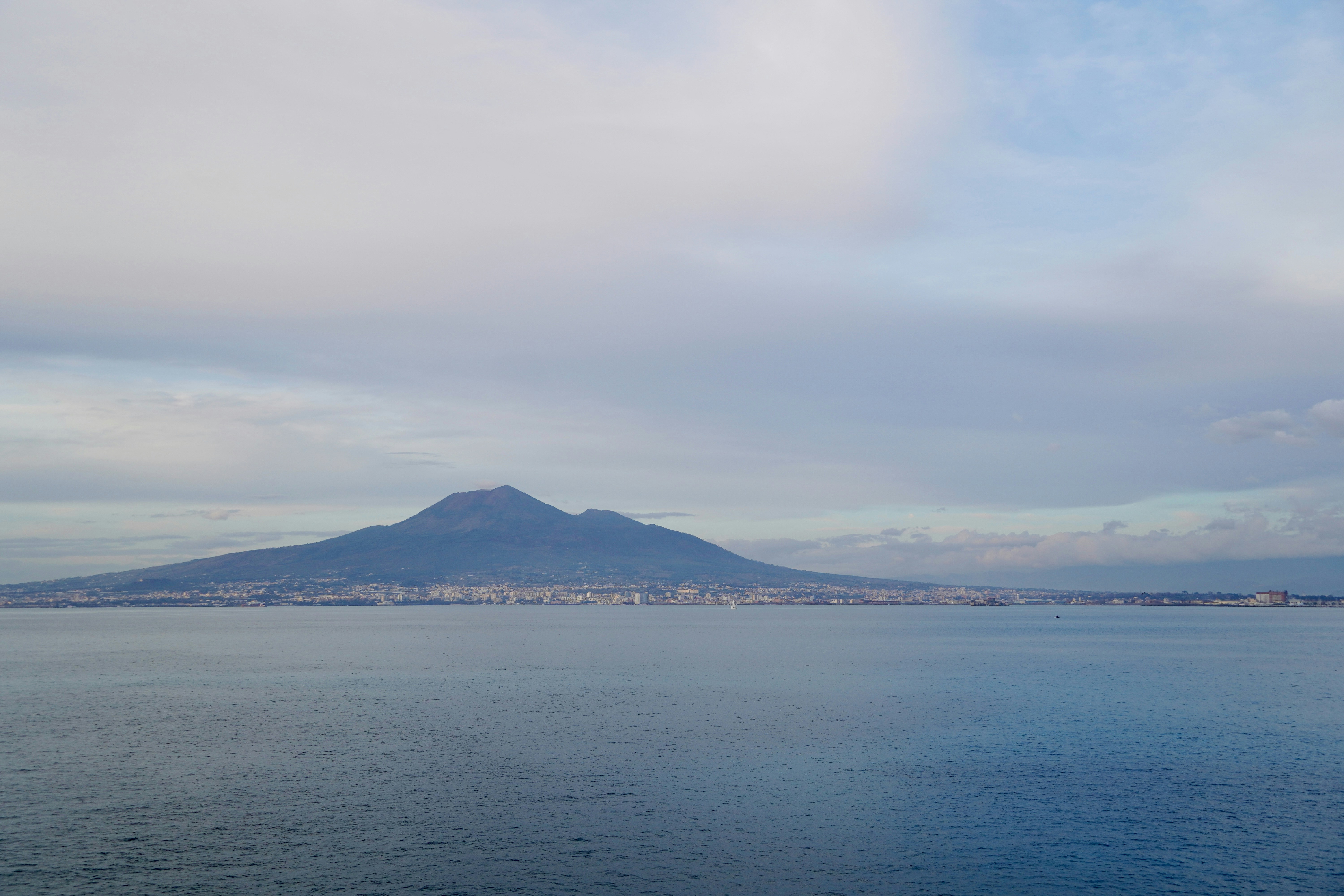 Calm Horizon: Mountain Rise Above a Quiet Sea