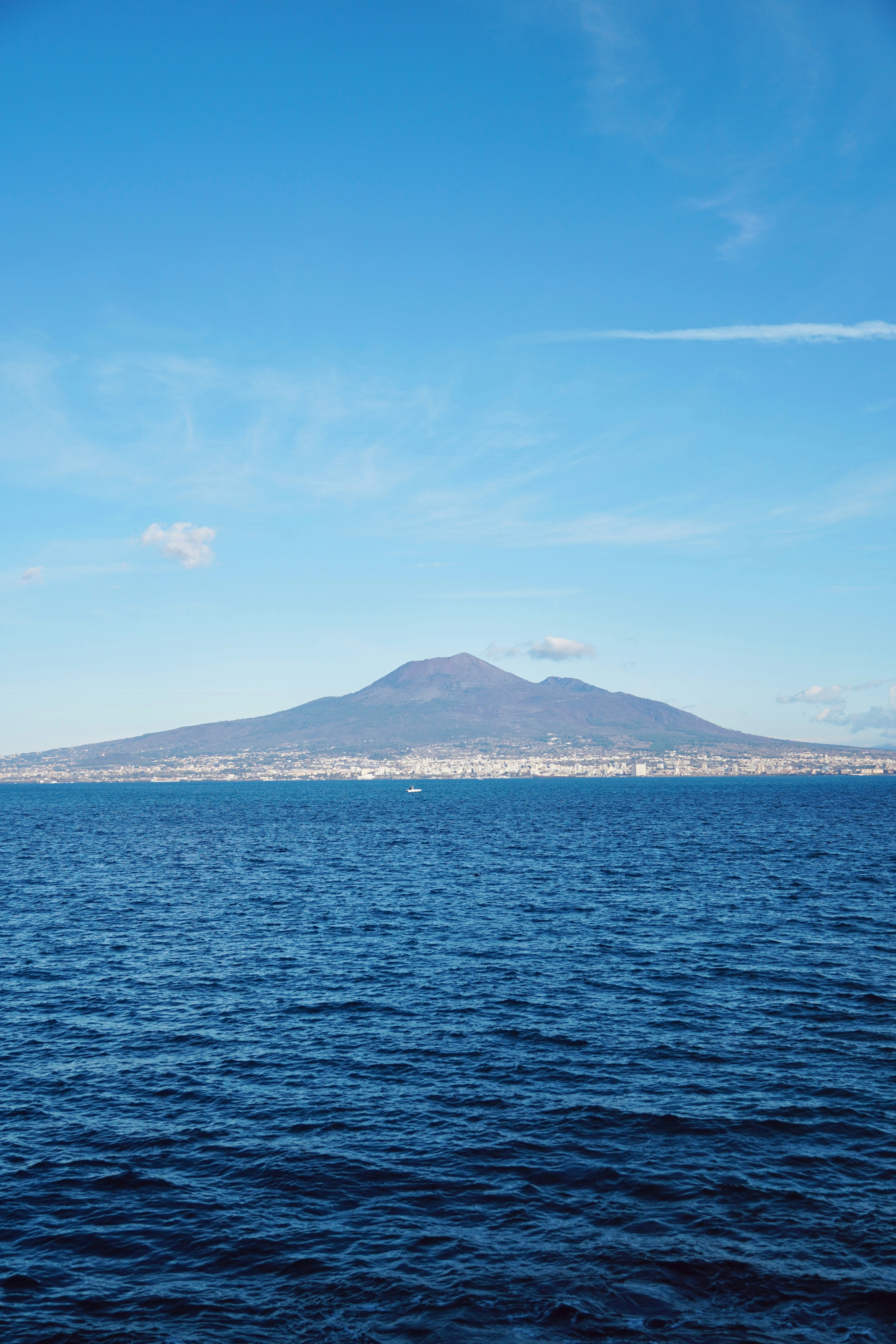 Azure Horizon: A Lone Vessel Between Sea and Sky