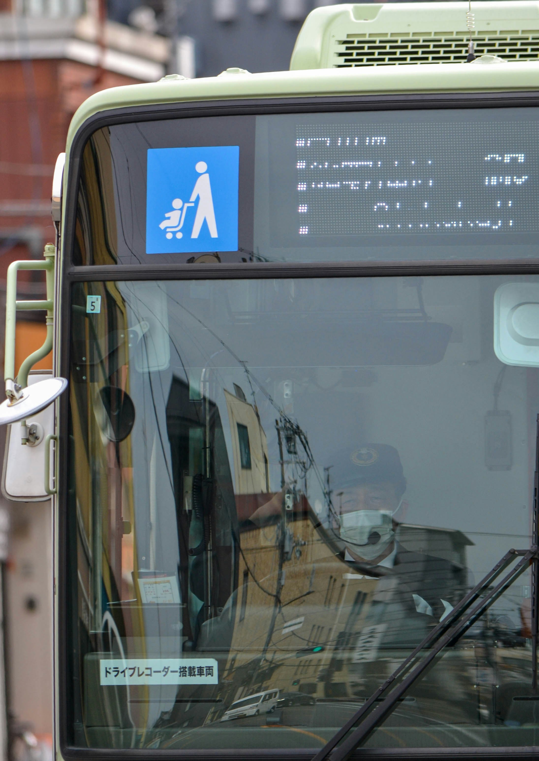 Front-Row View: City Bus Window Reflections and Signage