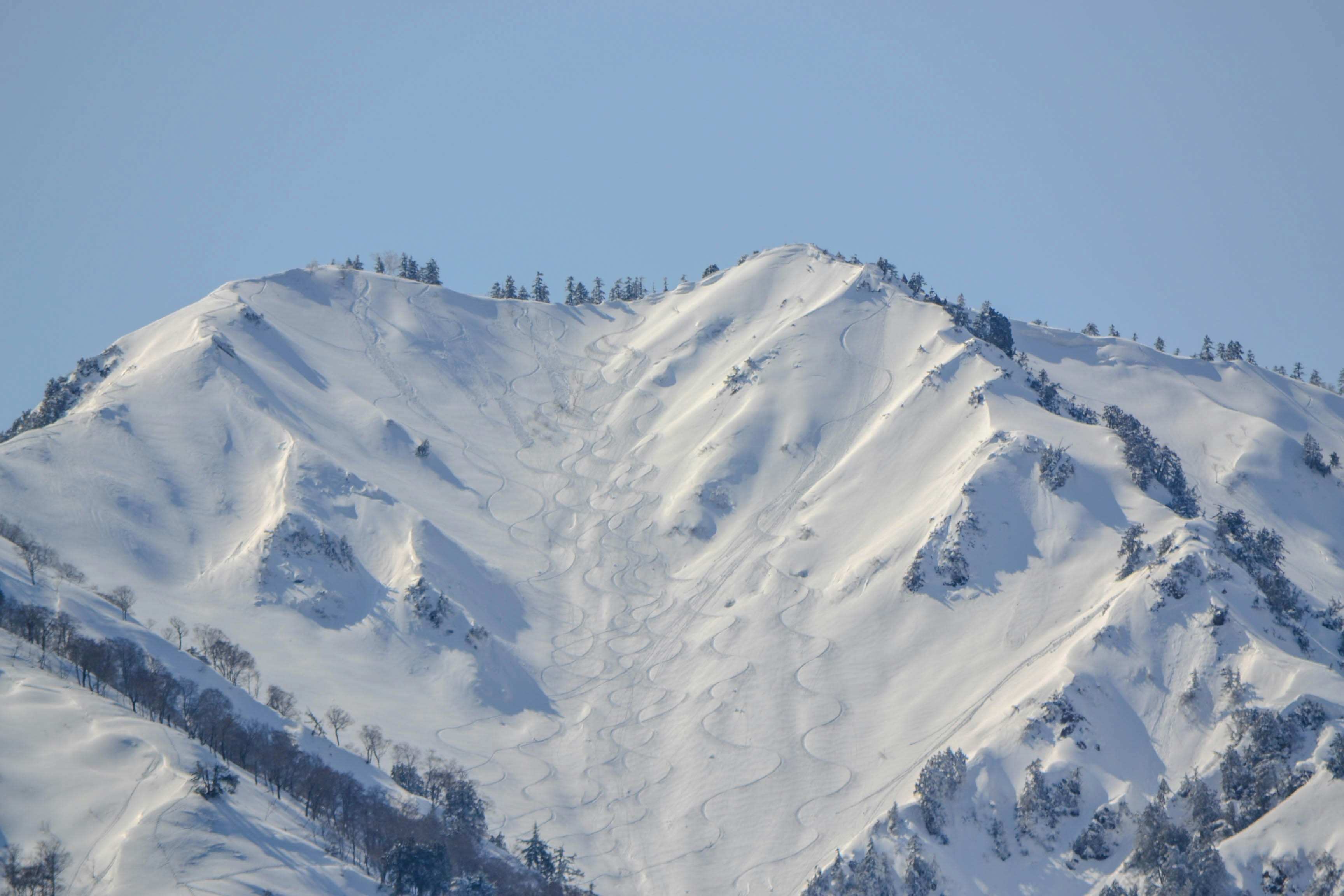 Snowbound Ridge: A Quiet Gradient of Light on the Mountain Peak