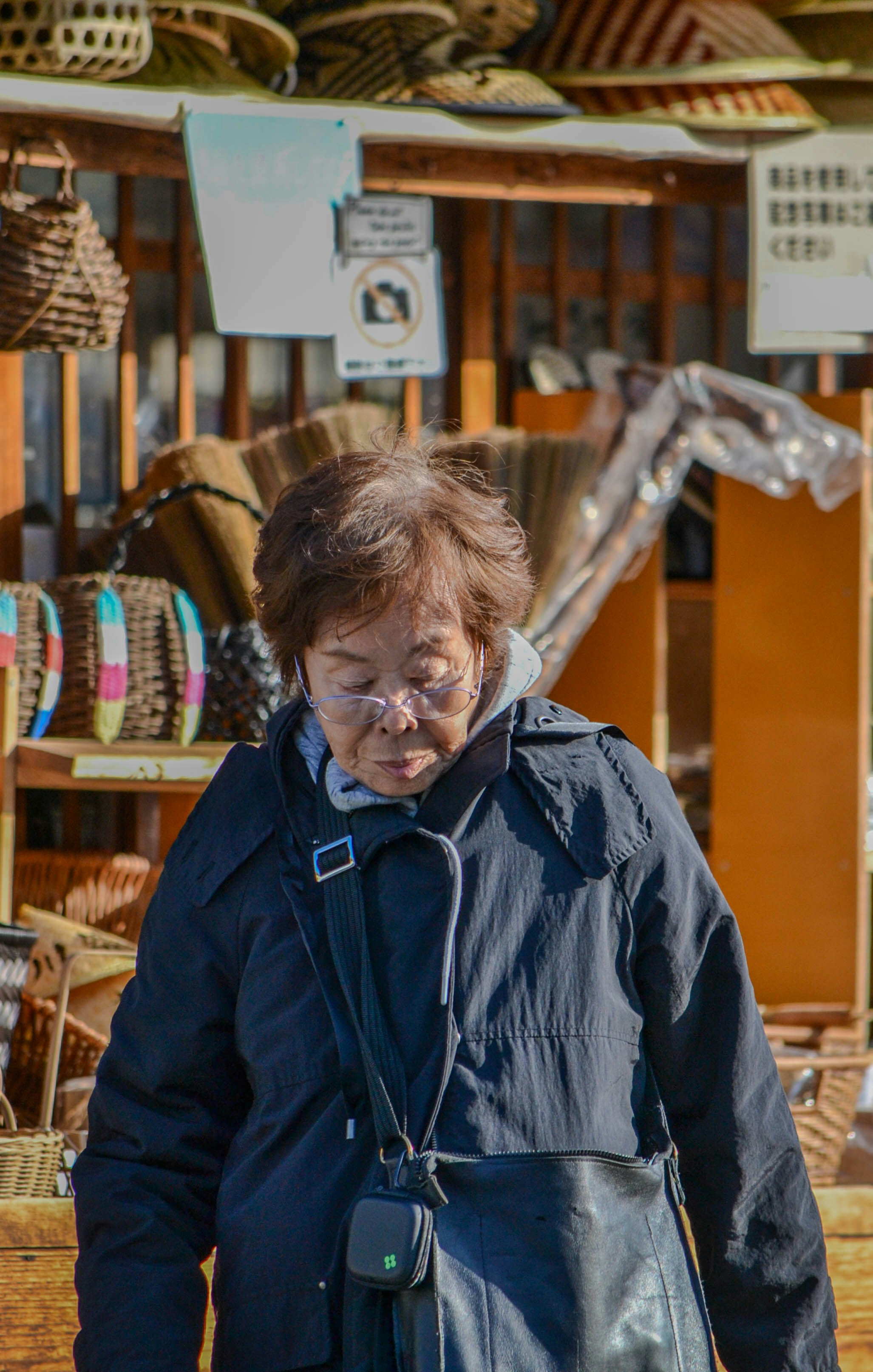 Market Portrait: Elderly Vendor in Sunlit Stall