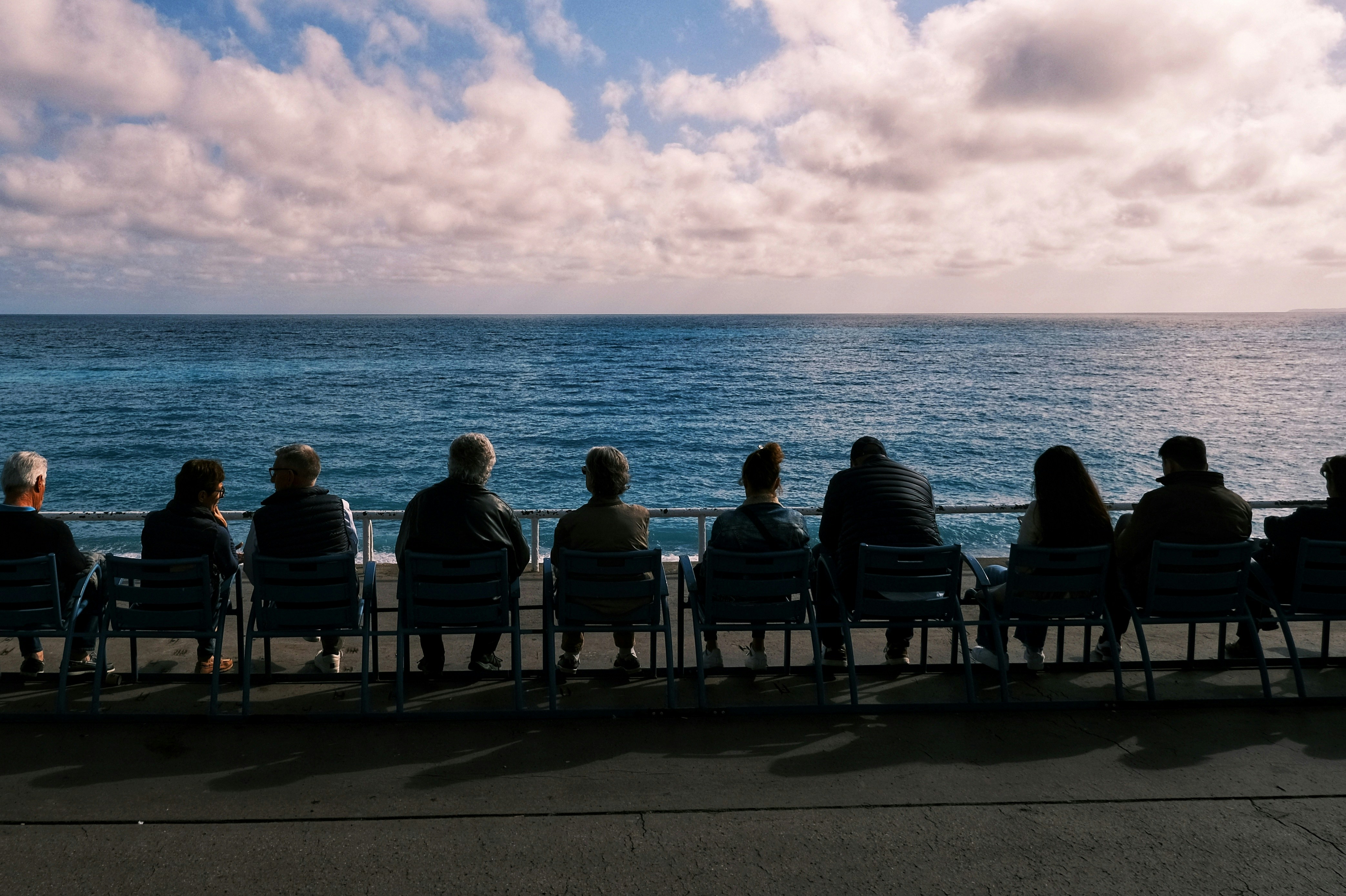 Line of Quiet Mariners Gazing at a Sea of Blue
