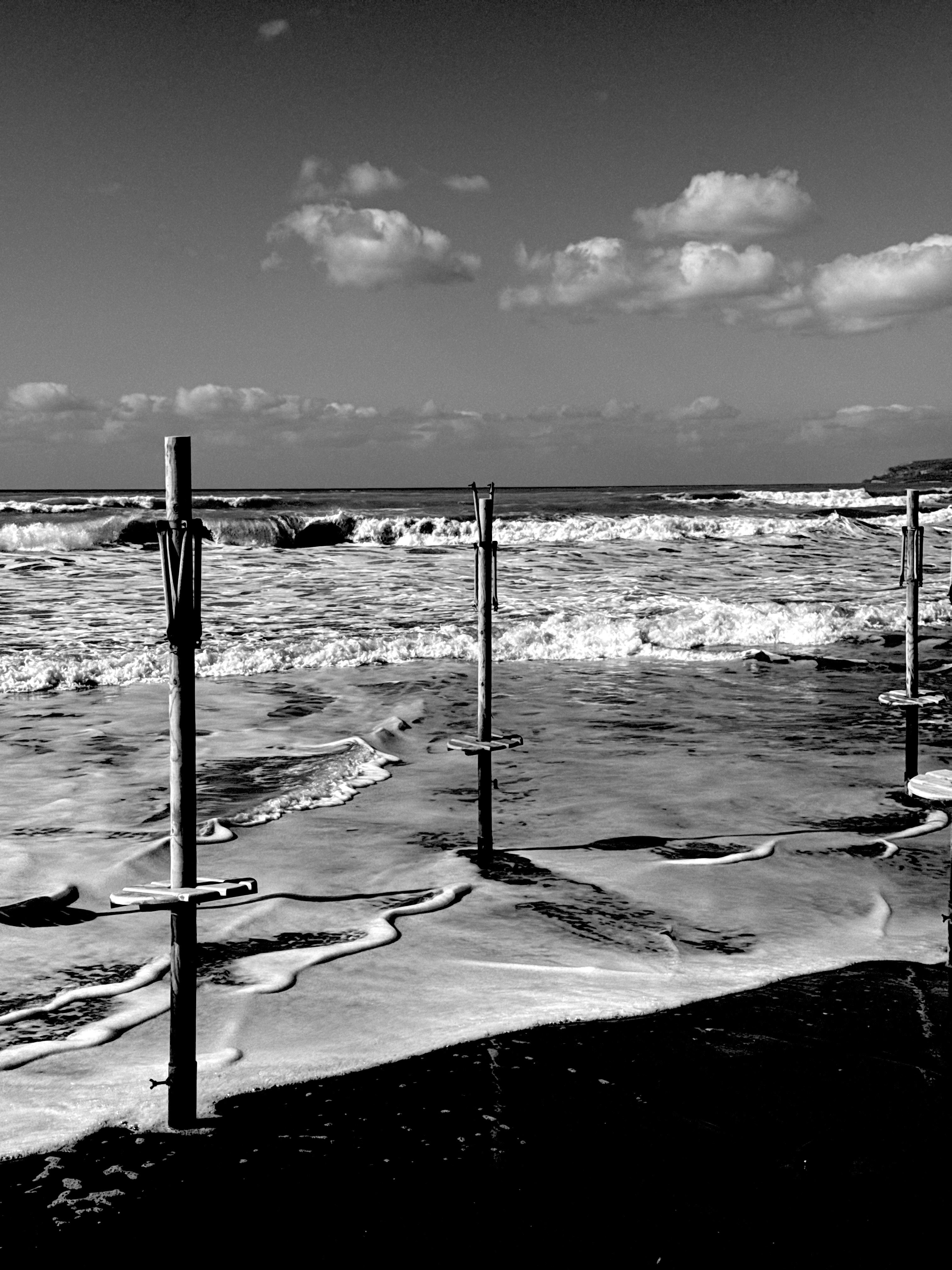 Stormy Shore Stanchions: A Quiet Row Across Tidal Lines