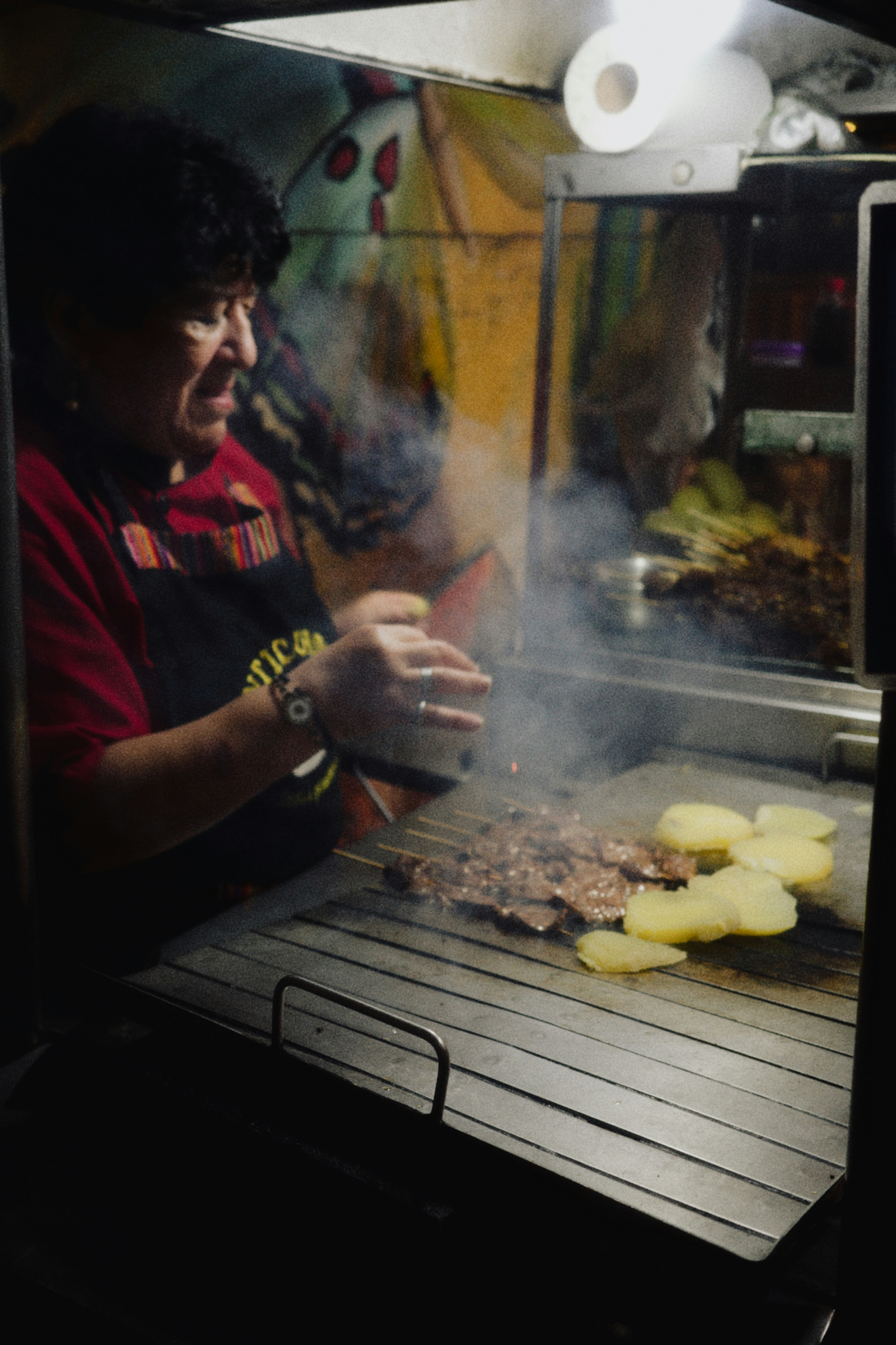 Grillside Portrait: The Cook at Work Smokes and Sizzles