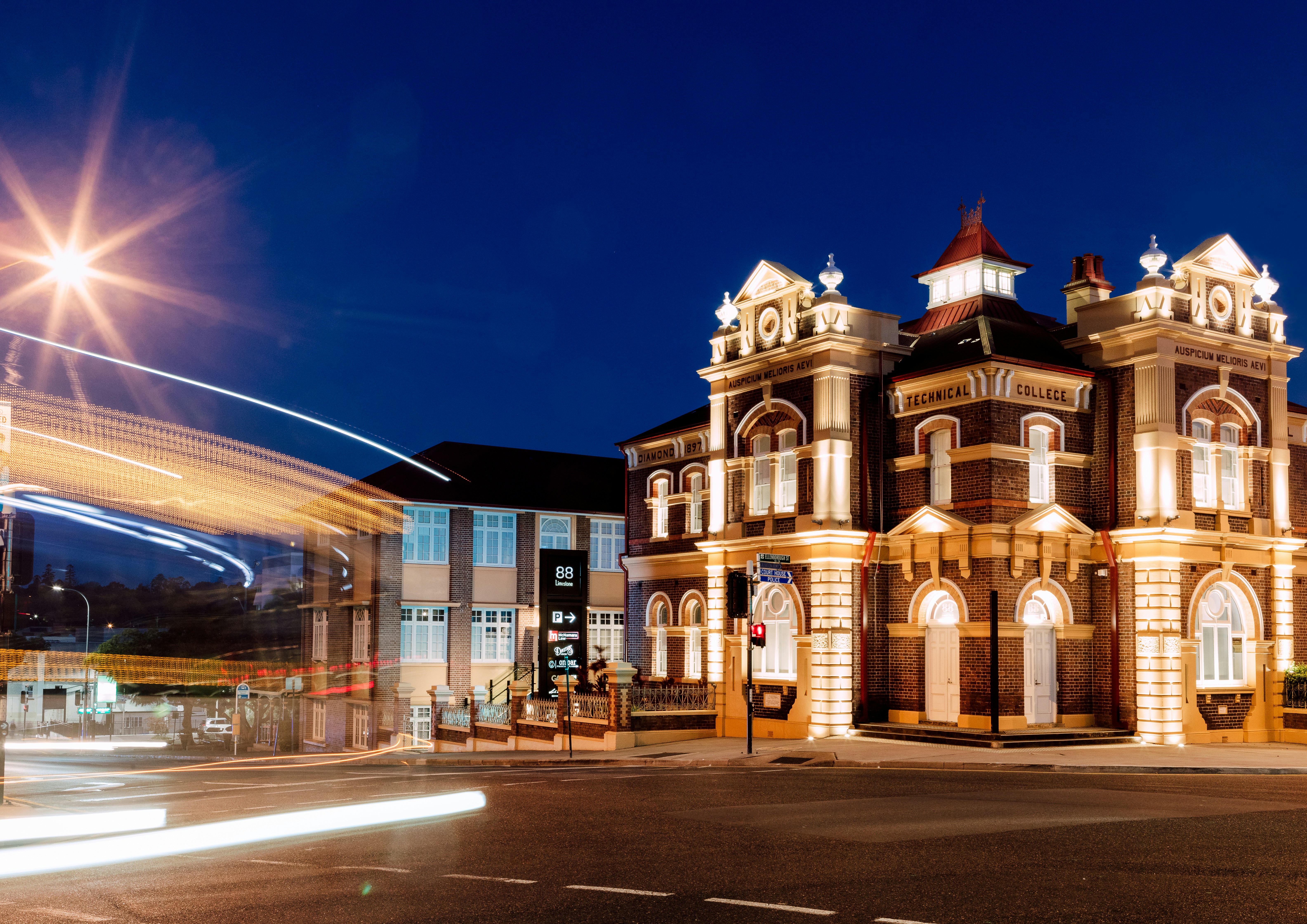 Neo-Gothic Corner: Night-lit Station with Light Trails