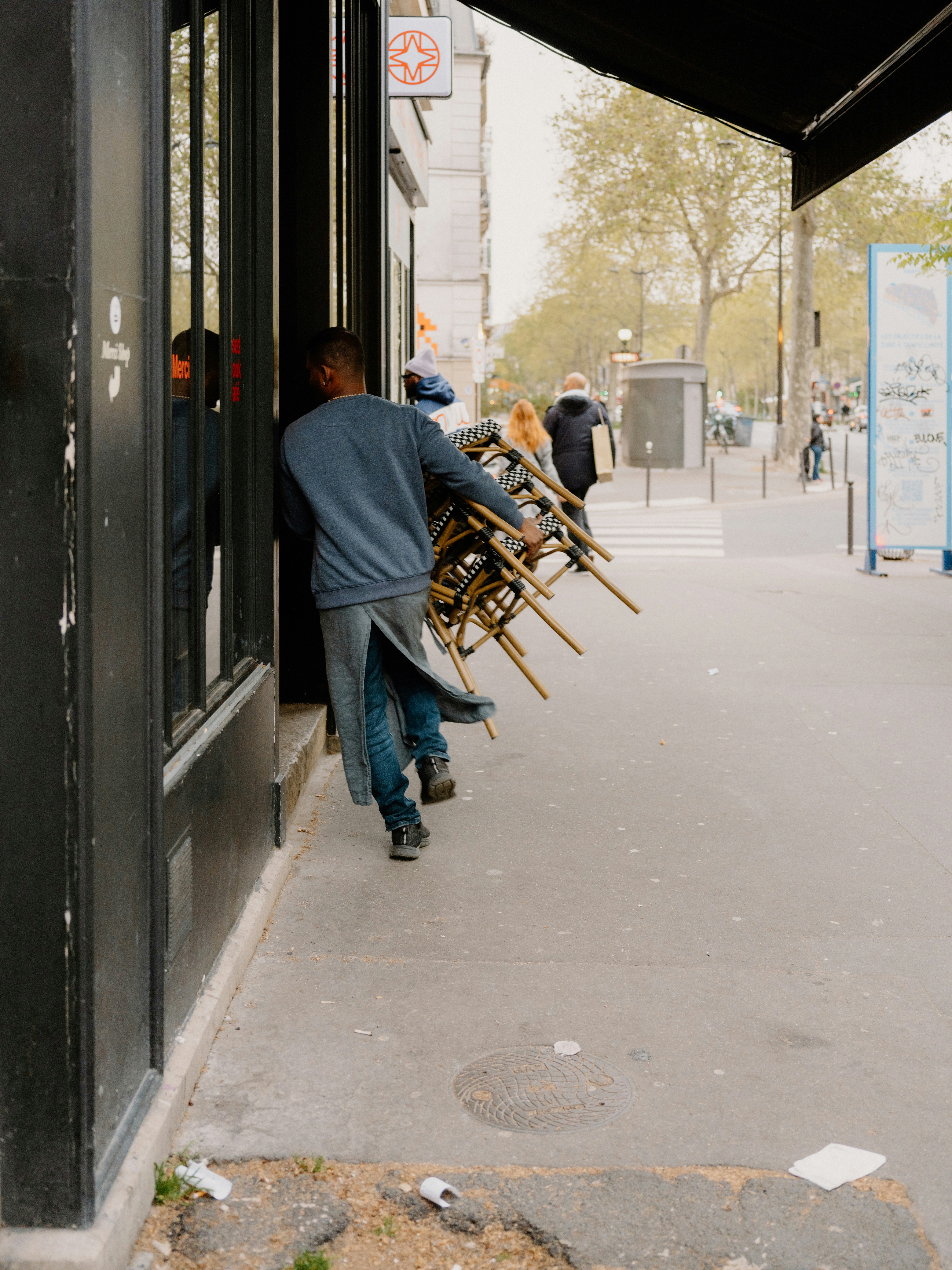 The Folded Chairs and the Walking Crew on a City Street