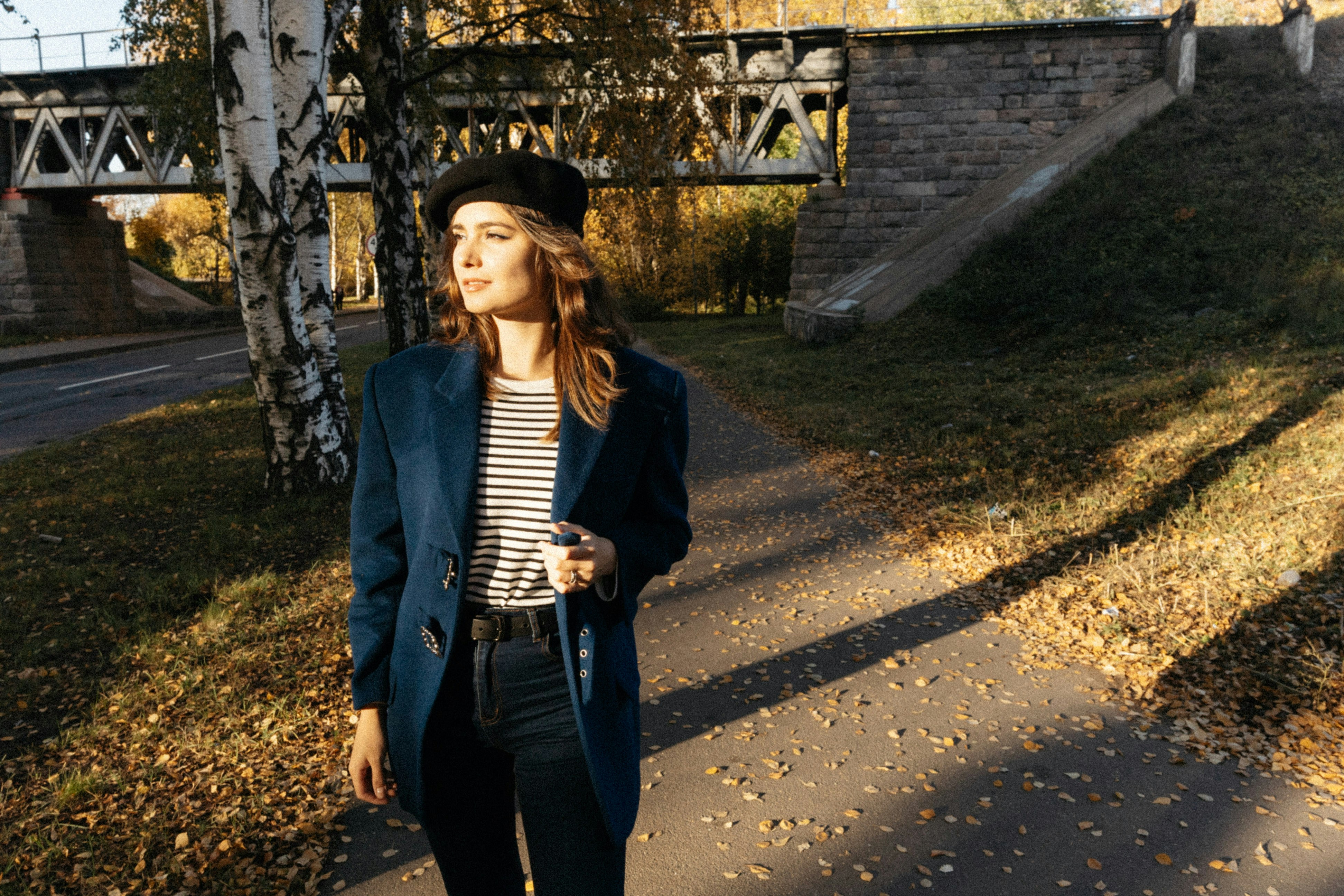 Autumn Walk Under the Bridge: A Portrait in Warm Light