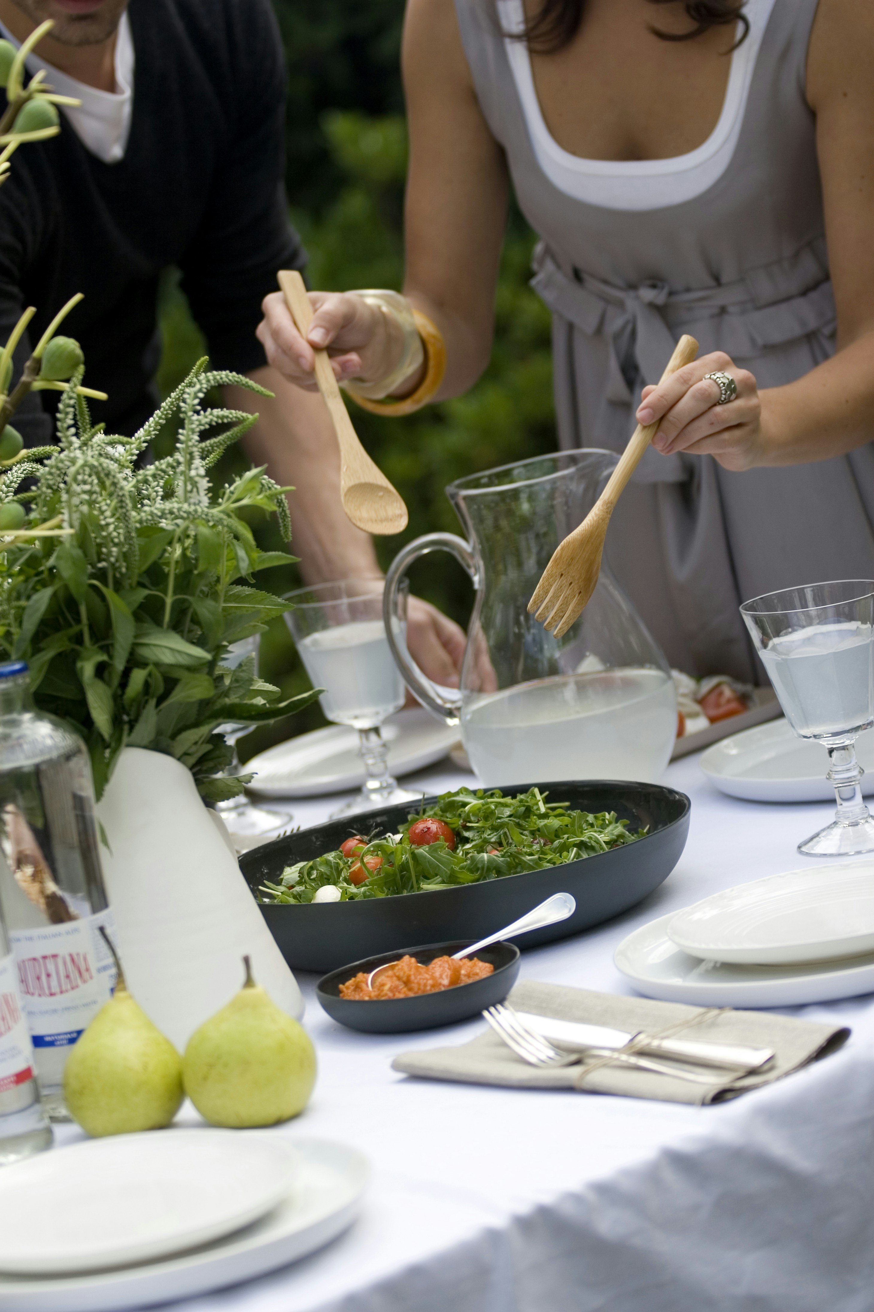Garden Table Drama: Wooden Spoons Hover Over a Fresh Spread